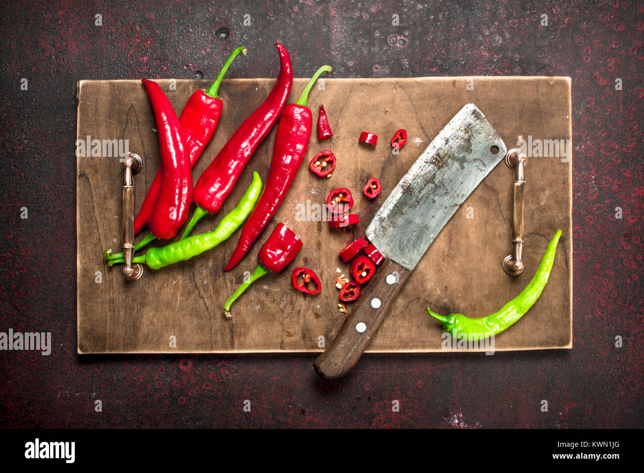 Sliced hot pepper on an old board. On a rustic background Stock Photo ...