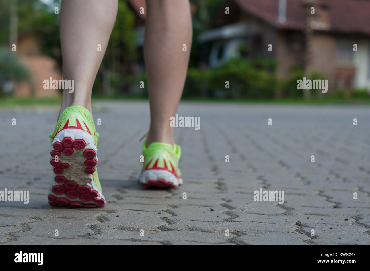 Runner woman feet running on road closeup on shoe. Female fitness ...