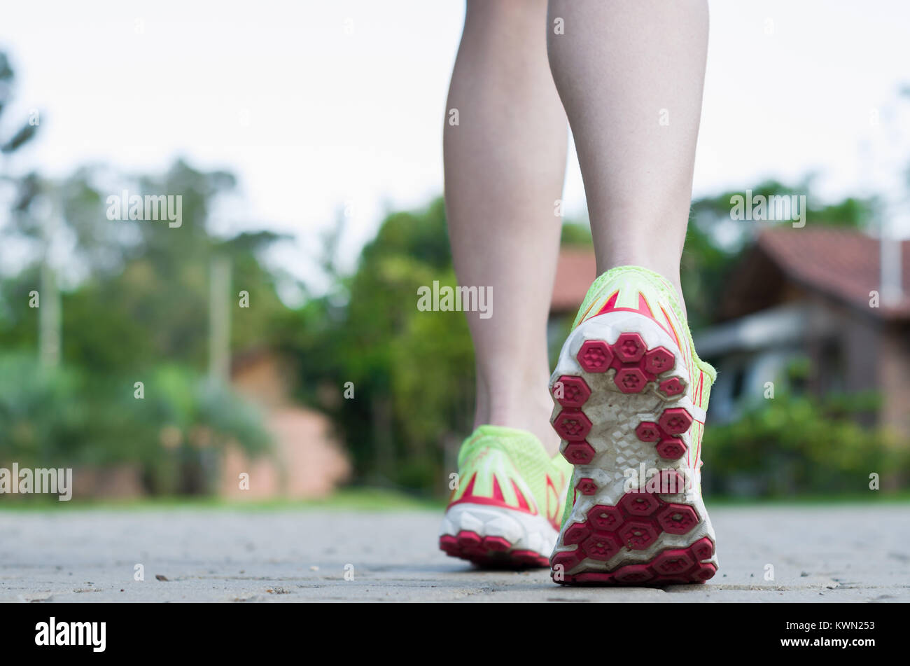 Runner woman feet running on road closeup on shoe. Female fitness ...