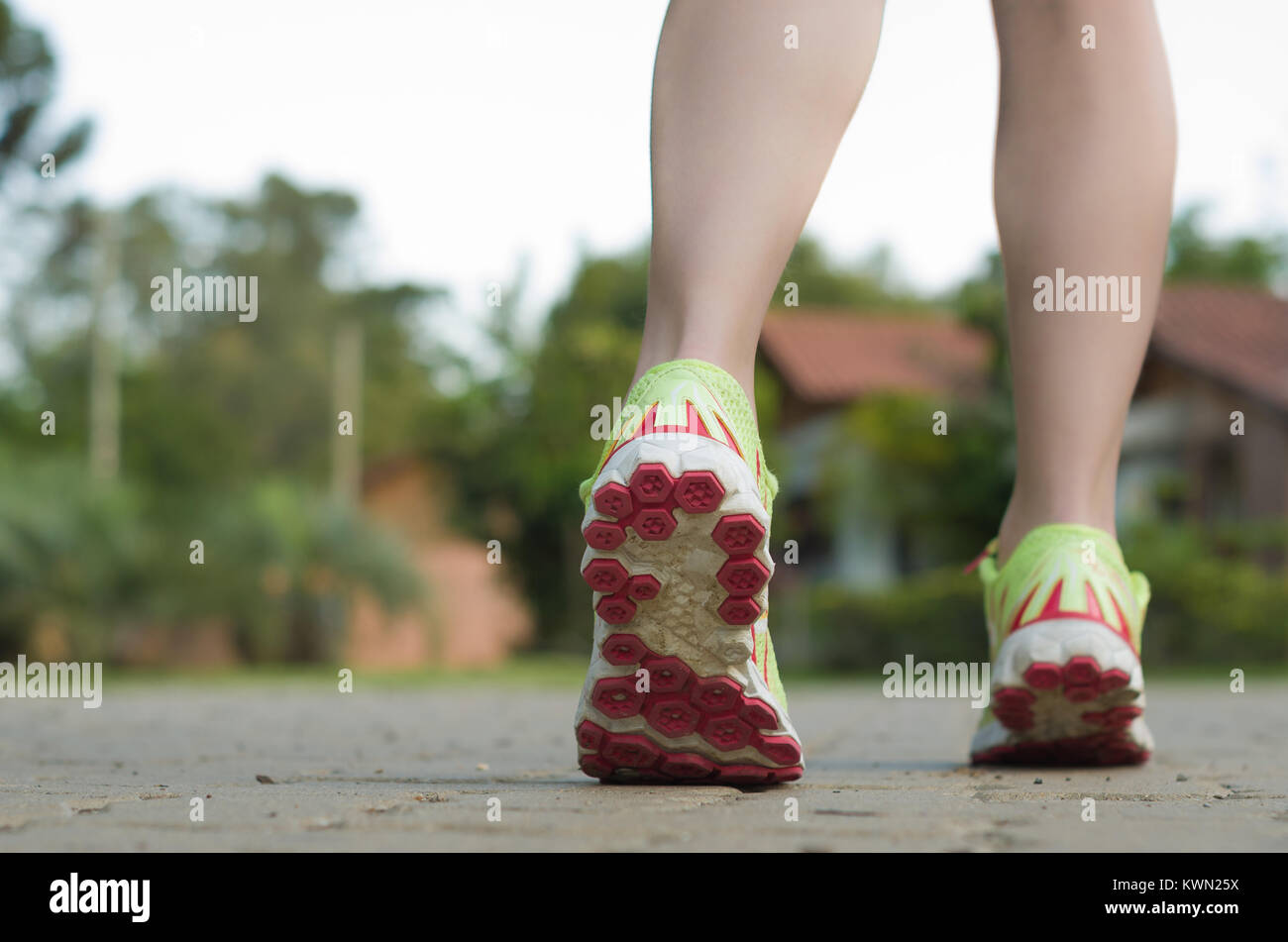 Runner woman feet running on road closeup on shoe. Female fitness ...