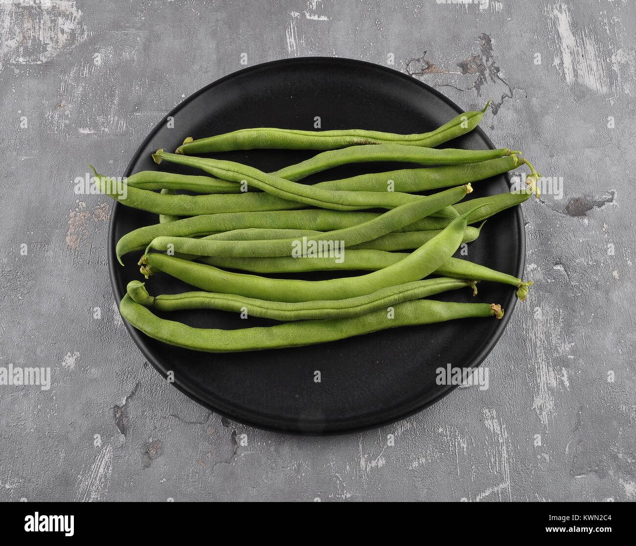 Beans on plate and concrete Stock Photo - Alamy
