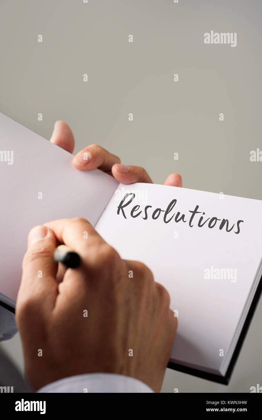 closeup of a young caucasian man in an elegant suit about to write a ...