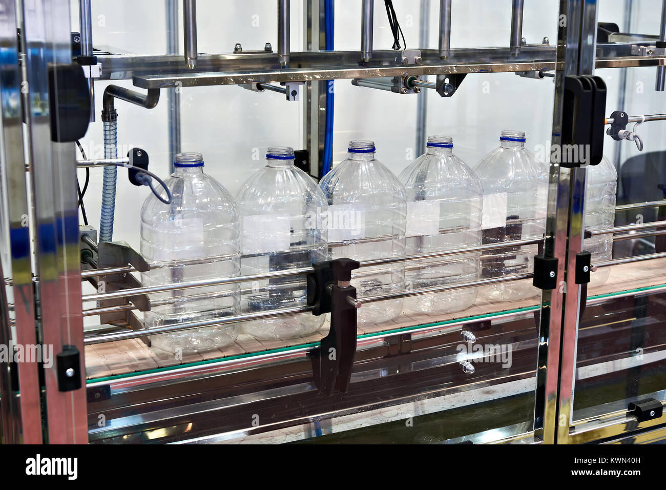 Conveyor with empty plastic bottles for food industry Stock Photo - Alamy