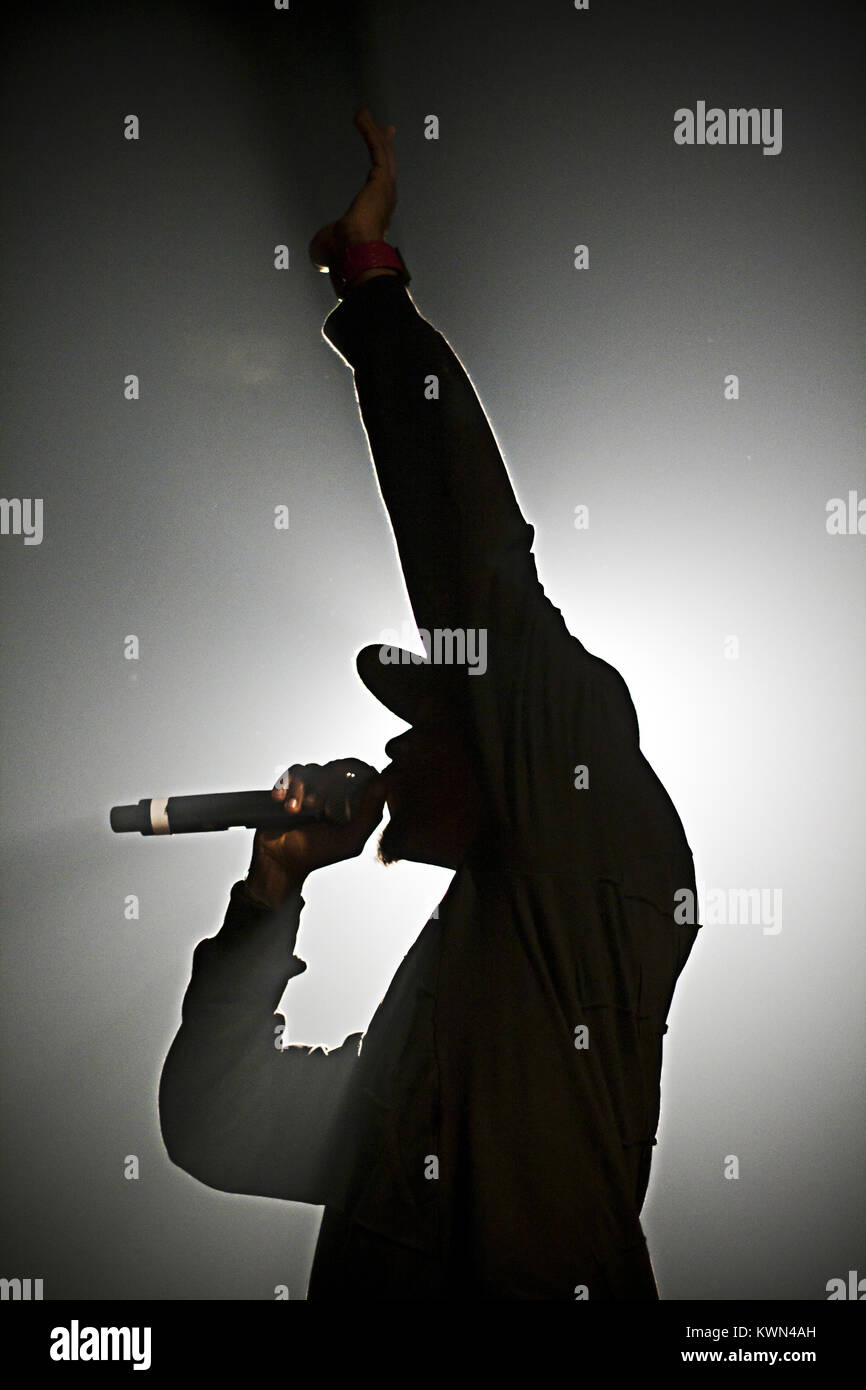 A singer, rapper and musician is pictured in silhouette live on stage ...