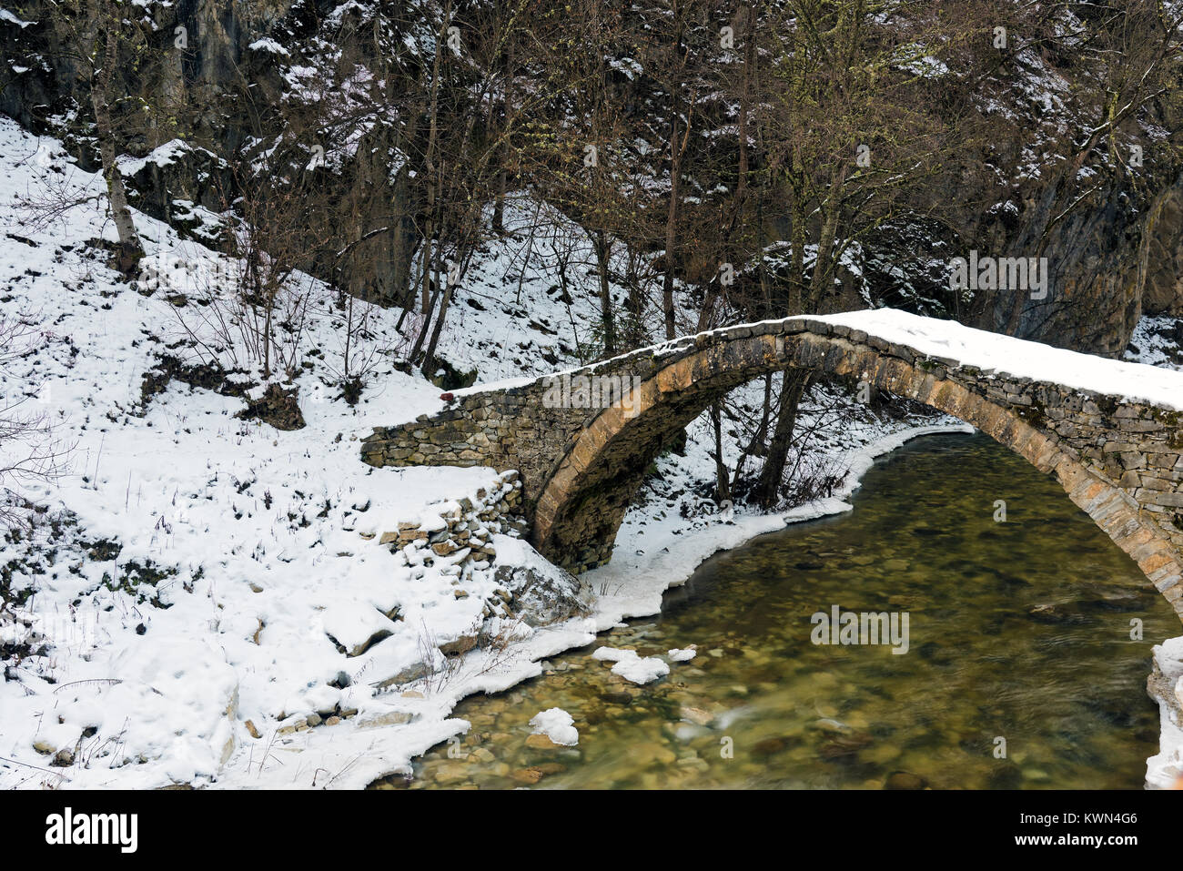 Snowy landscape with traditional stone bridge in Yagodina, Bulgaria ...