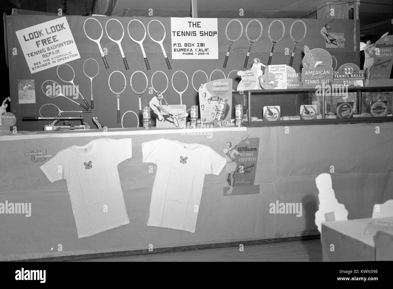 Tennis equipment is on display at a shop with signage reading The ...