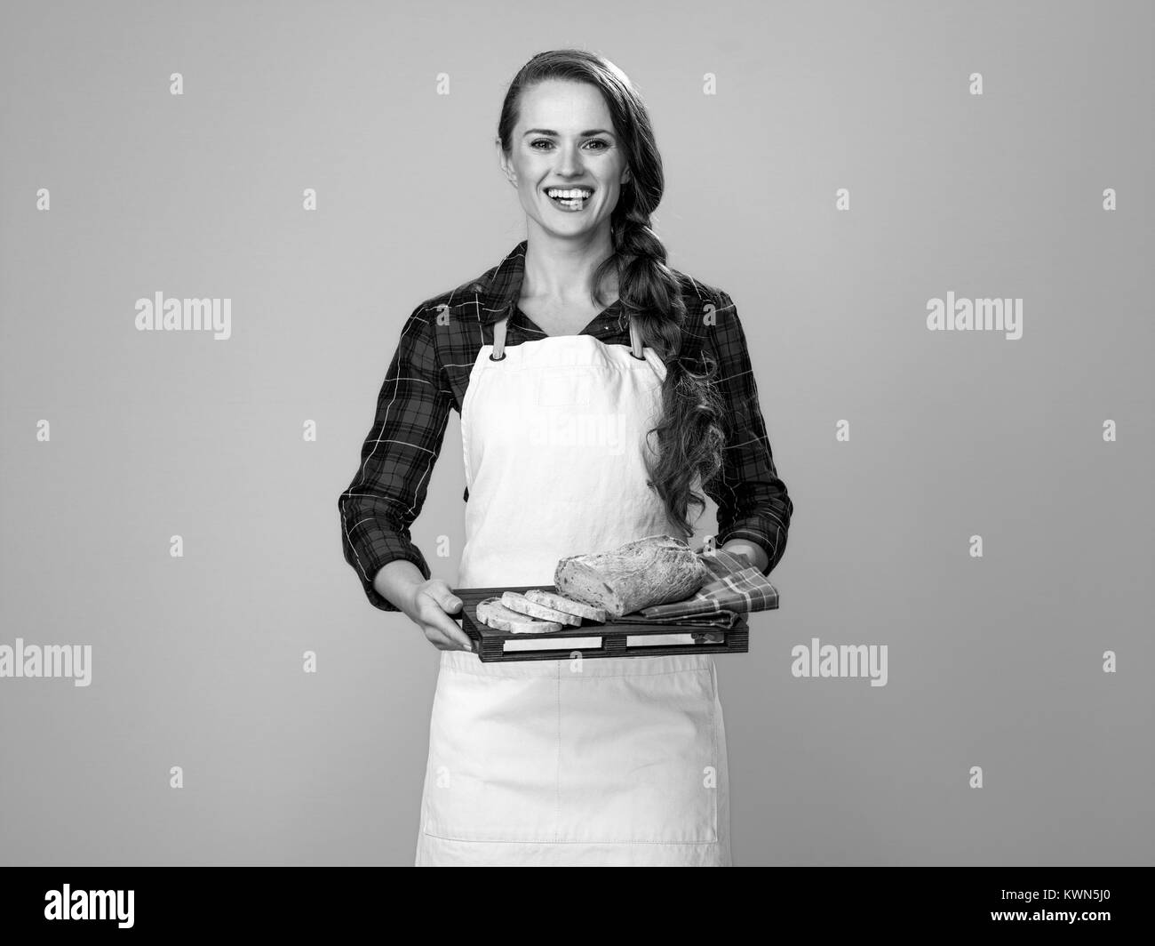 Healthy food to your table. Portrait of happy modern woman cook wearing ...