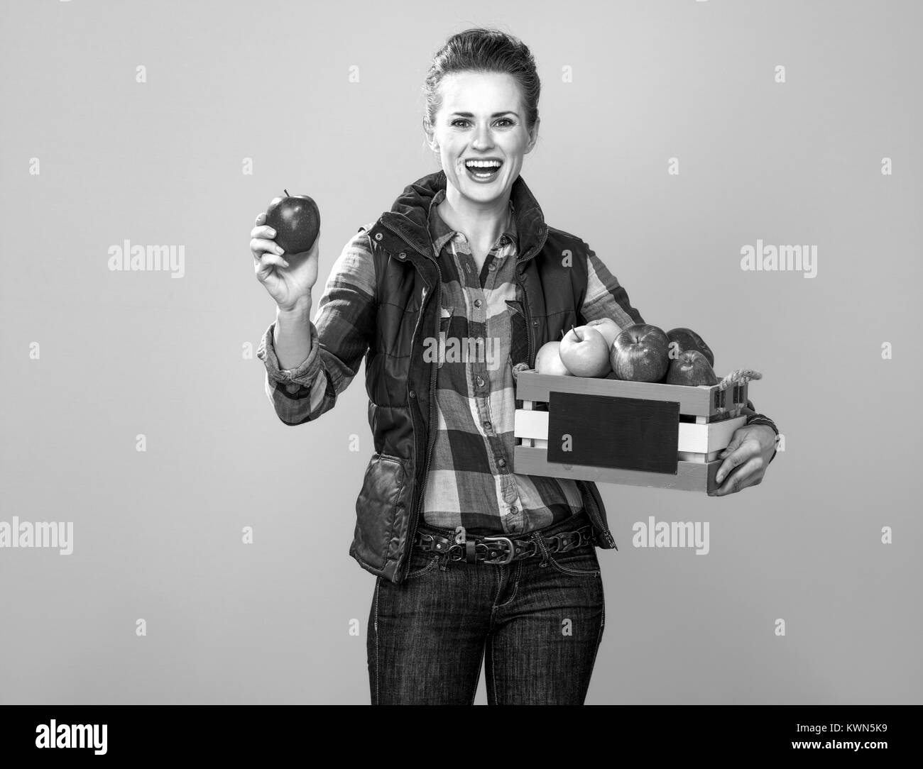 Healthy food to your table. Portrait of smiling young woman grower in ...
