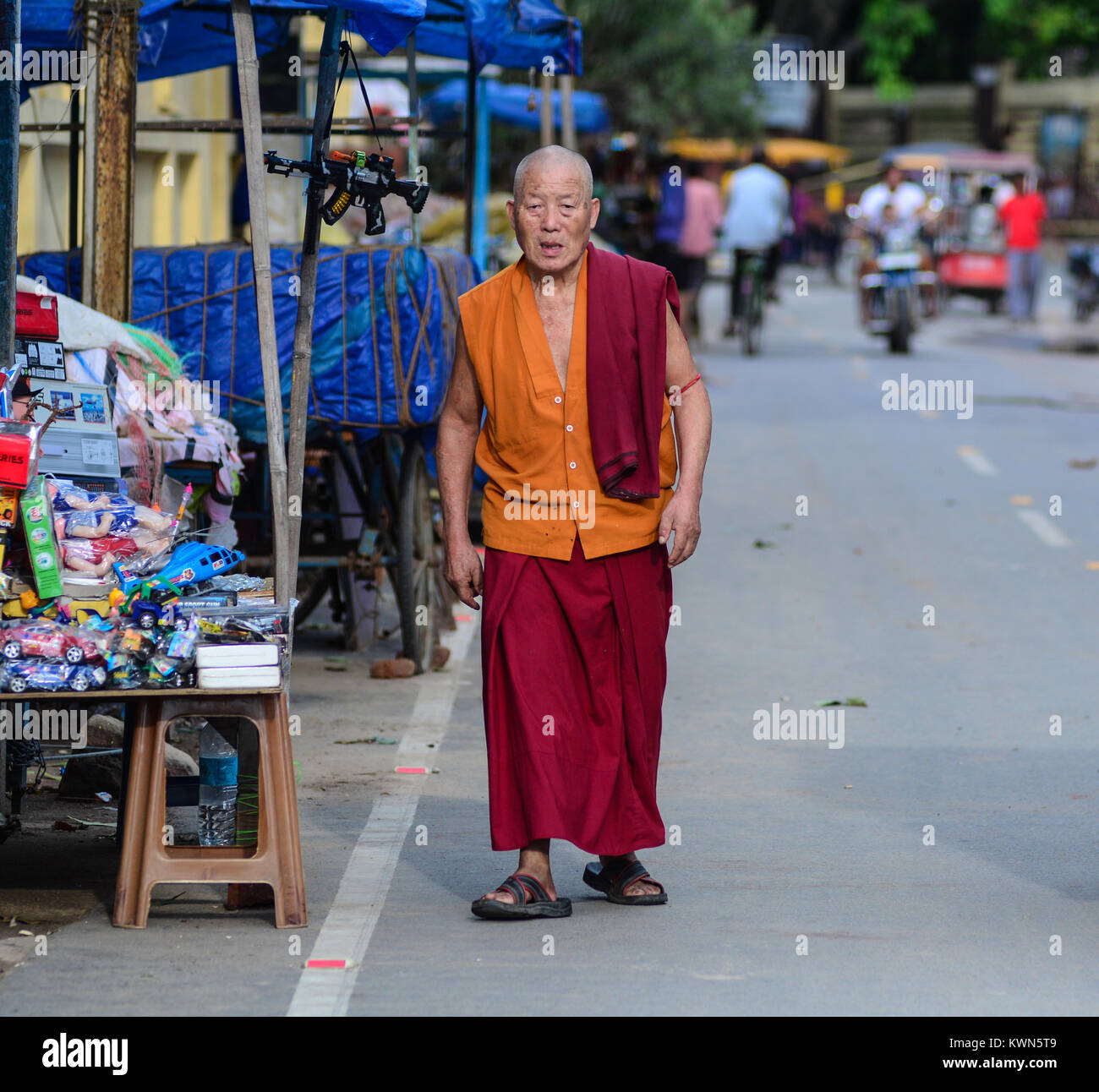 Bodhgaya, India - Jul 9, 2015. A Buddhist monk walking on street in ...