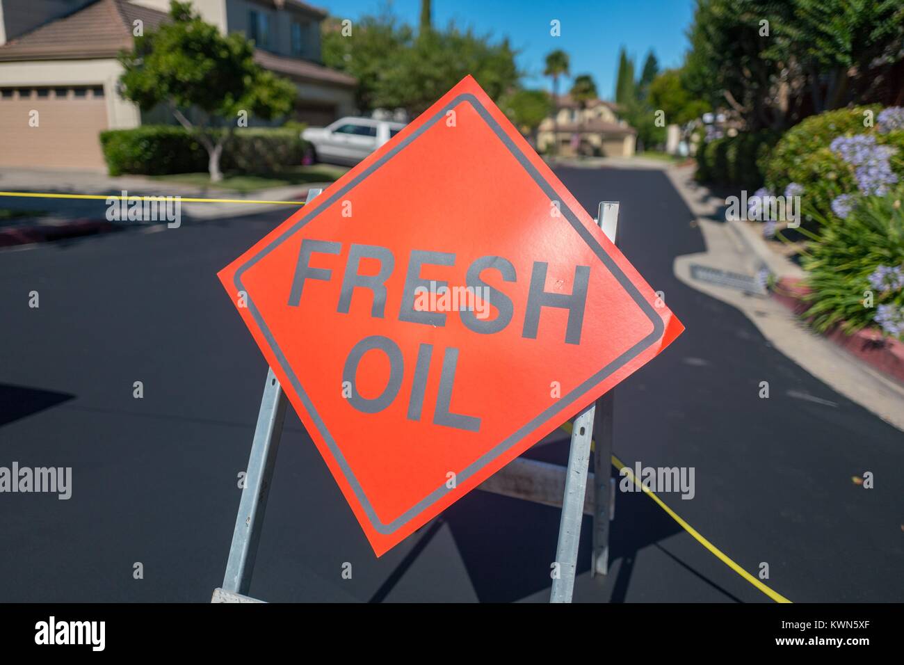 An orange road sign reading Fresh Oil at a construction site in San ...