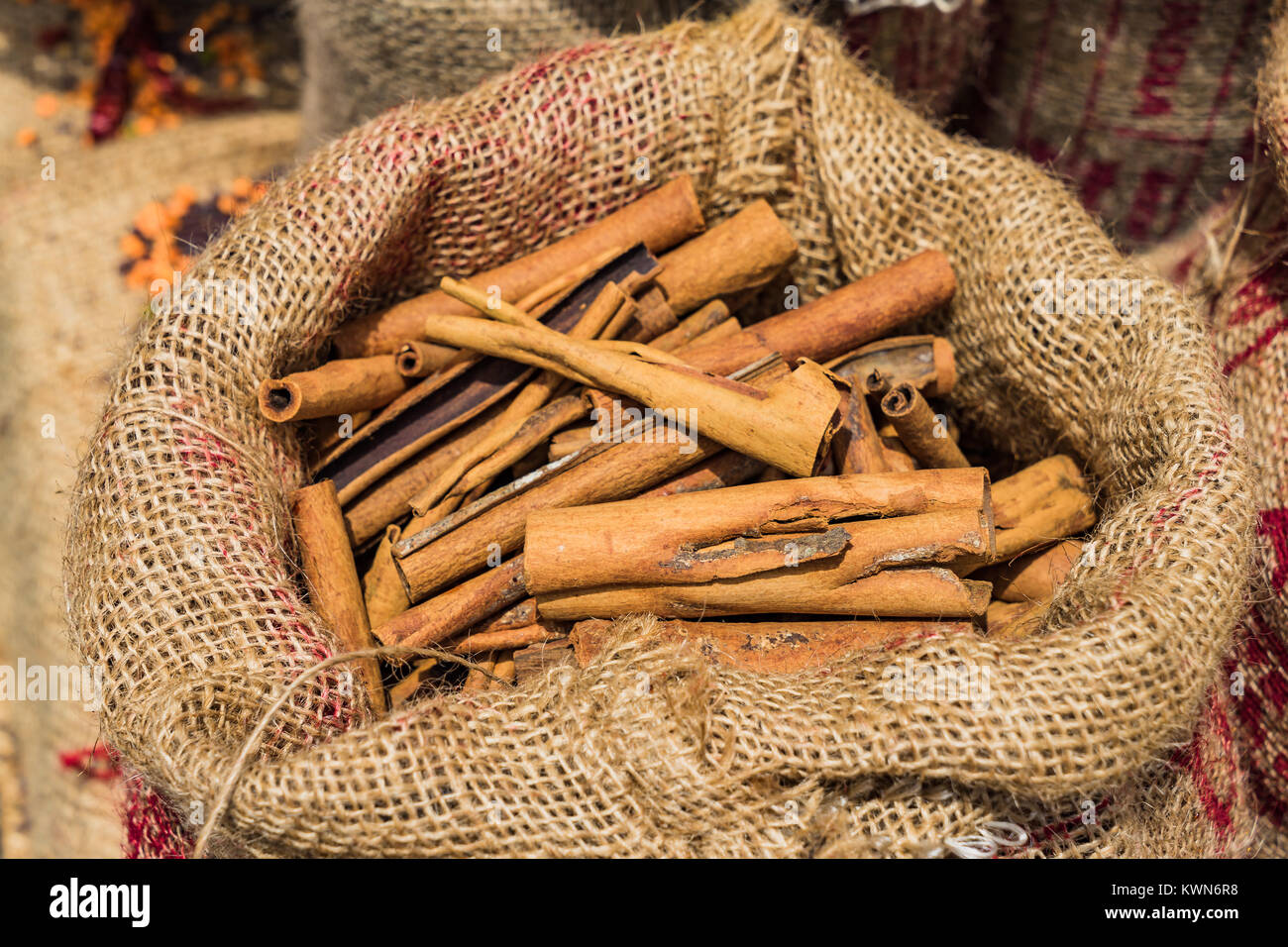 Sack of Cinnamon sticks background at market, Traditional spice for ...