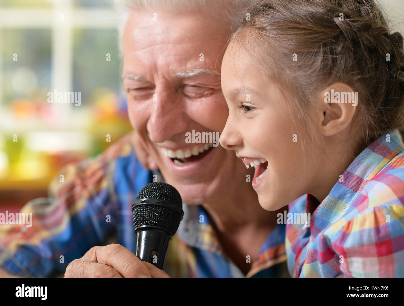 Child and elderly adult singing hi-res stock photography and images - Alamy
