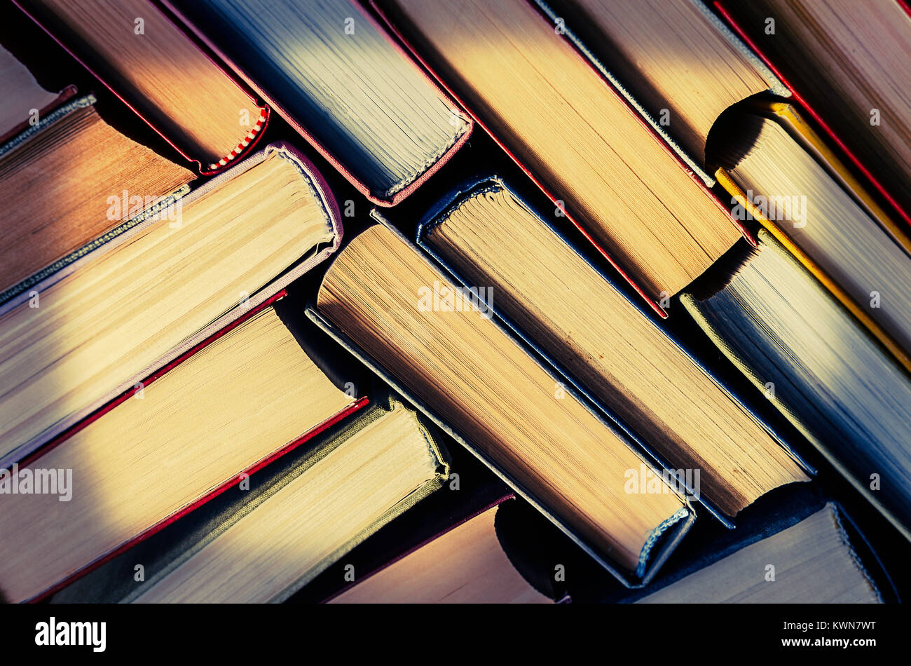a stack of colorful books in a library like background Stock Photo - Alamy