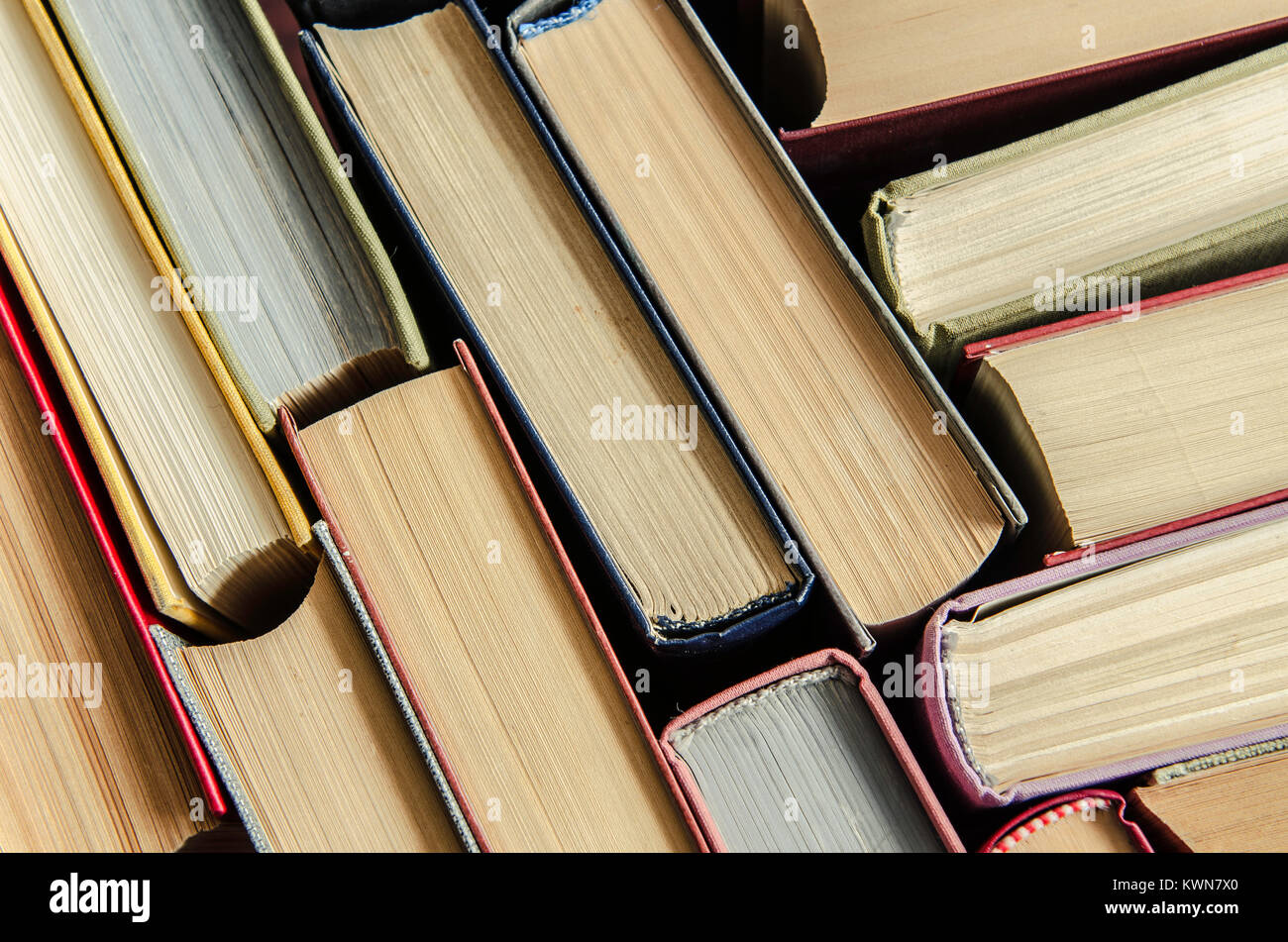 a stack of colorful books in a library like background Stock Photo - Alamy