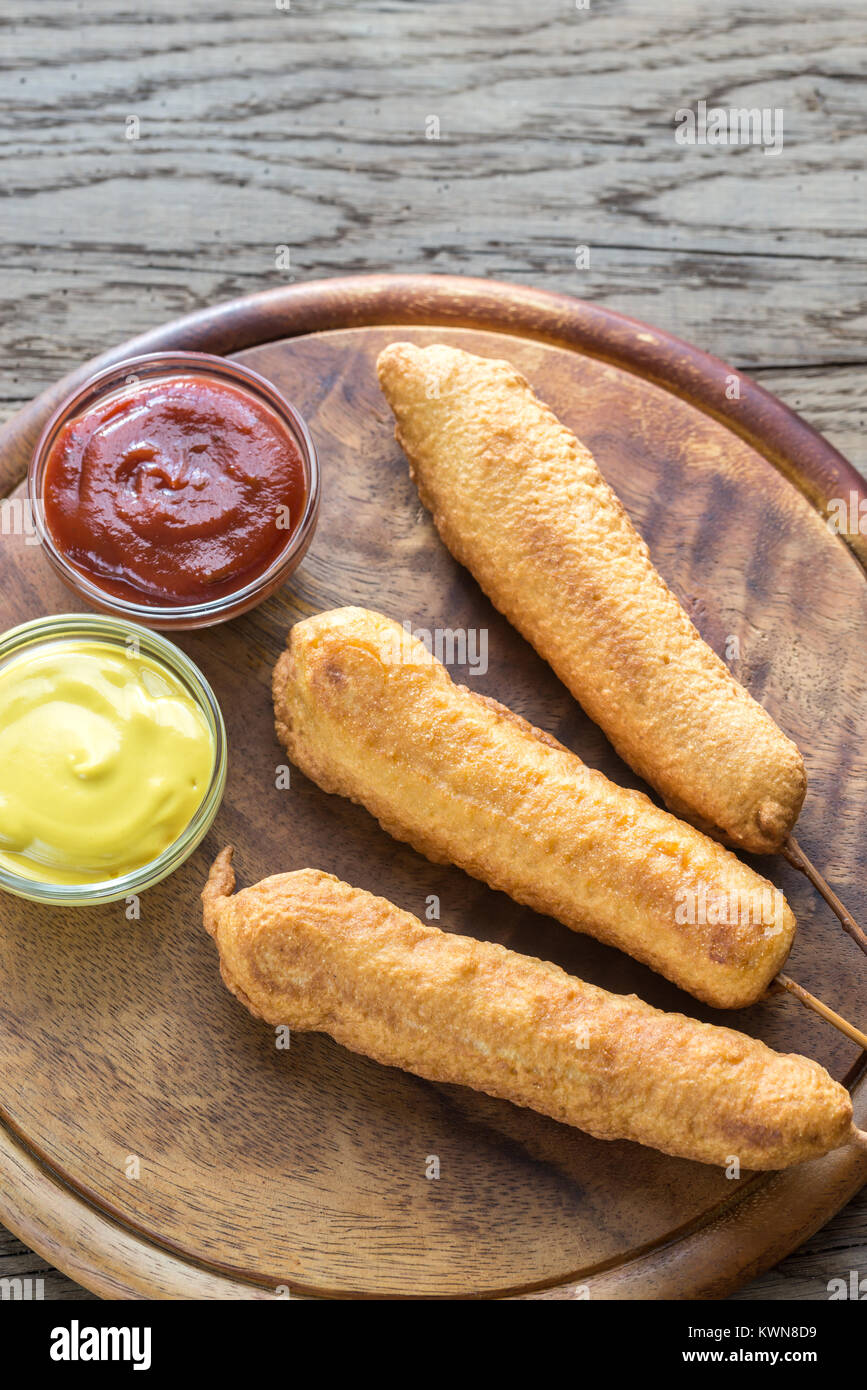 Stack of corn dogs on the wooden board Stock Photo - Alamy