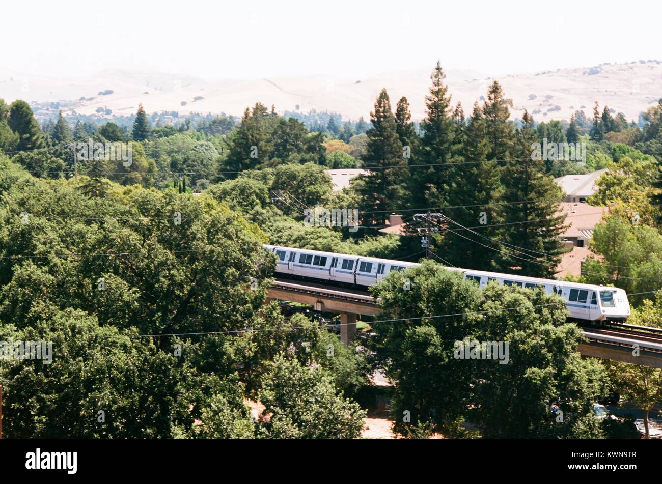 A Bay Area Rapid Transit (BART) train is seen passing through trees and ...