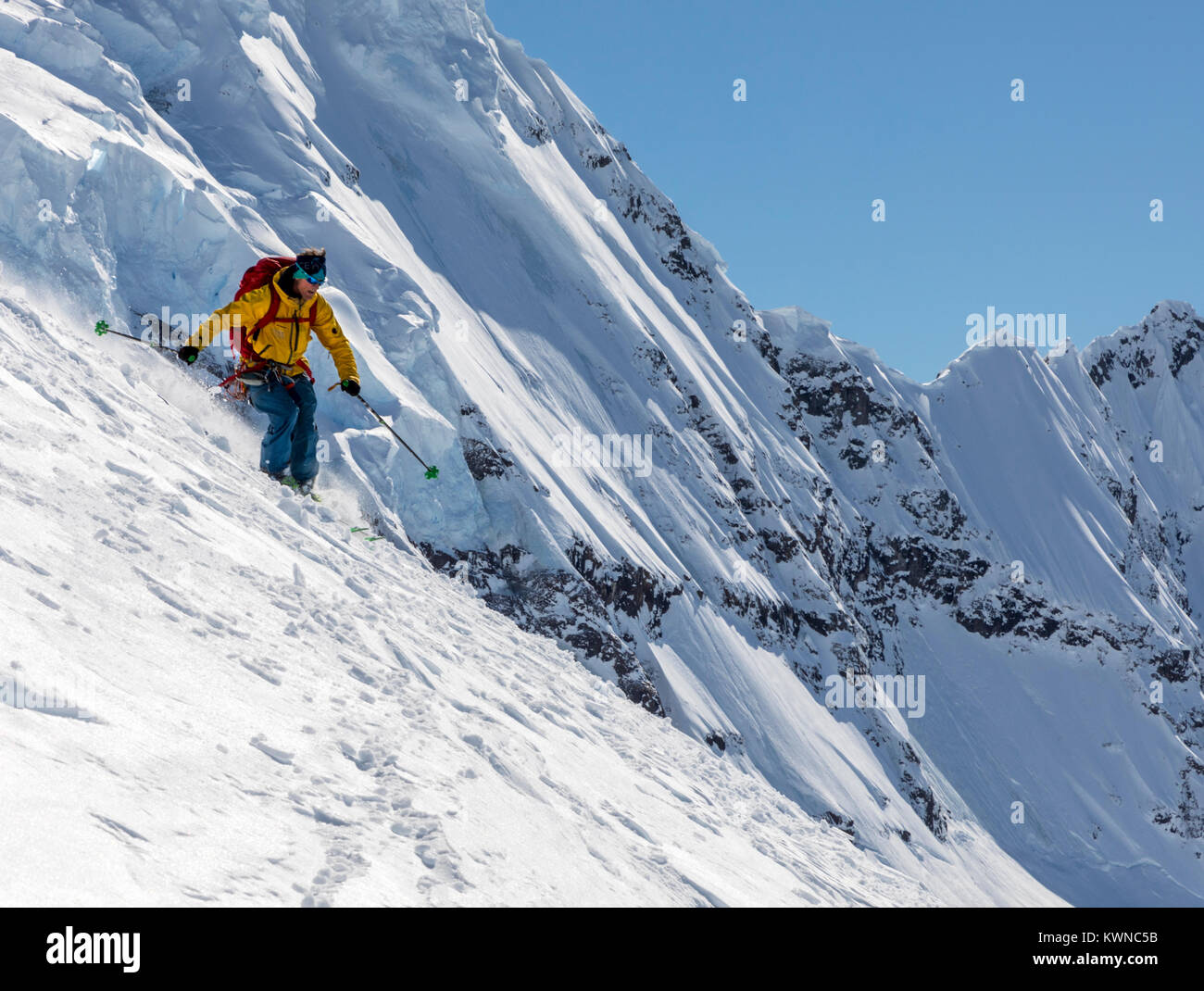 Alpine ski mountaineer skiing downhill in Antarctica; Nansen Island ...