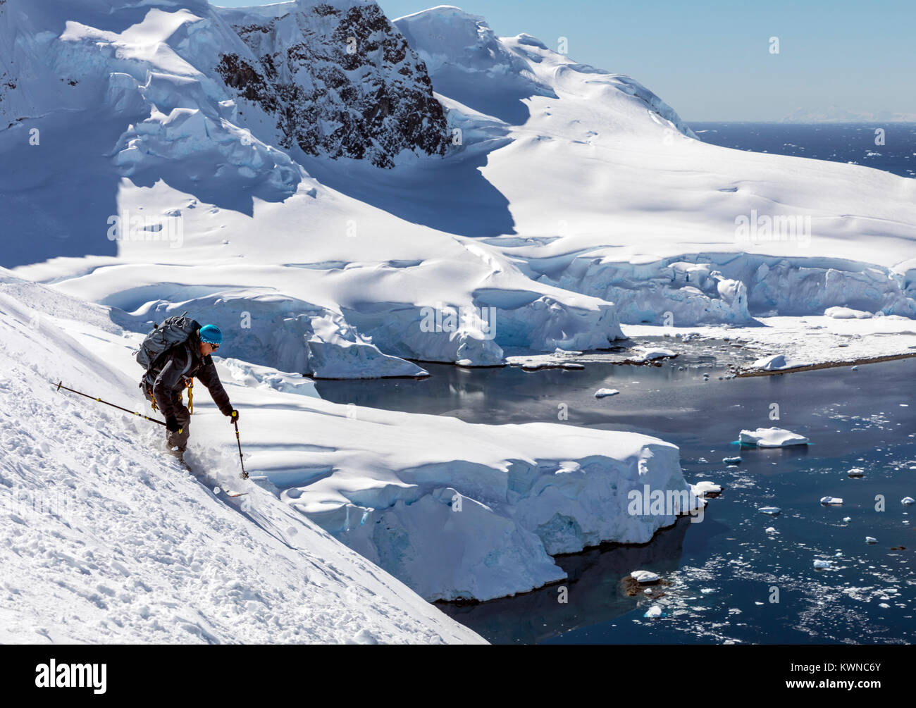 Alpine ski mountaineer skiing downhill in Antarctica; Nansen Island ...