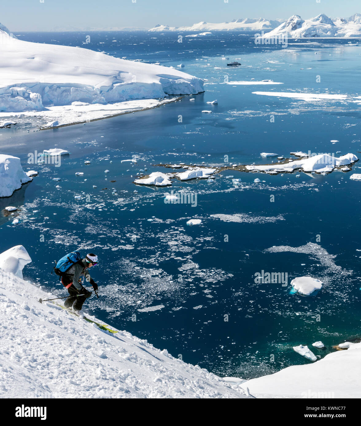 Alpine ski mountaineer skiing downhill in Antarctica; Nansen Island ...