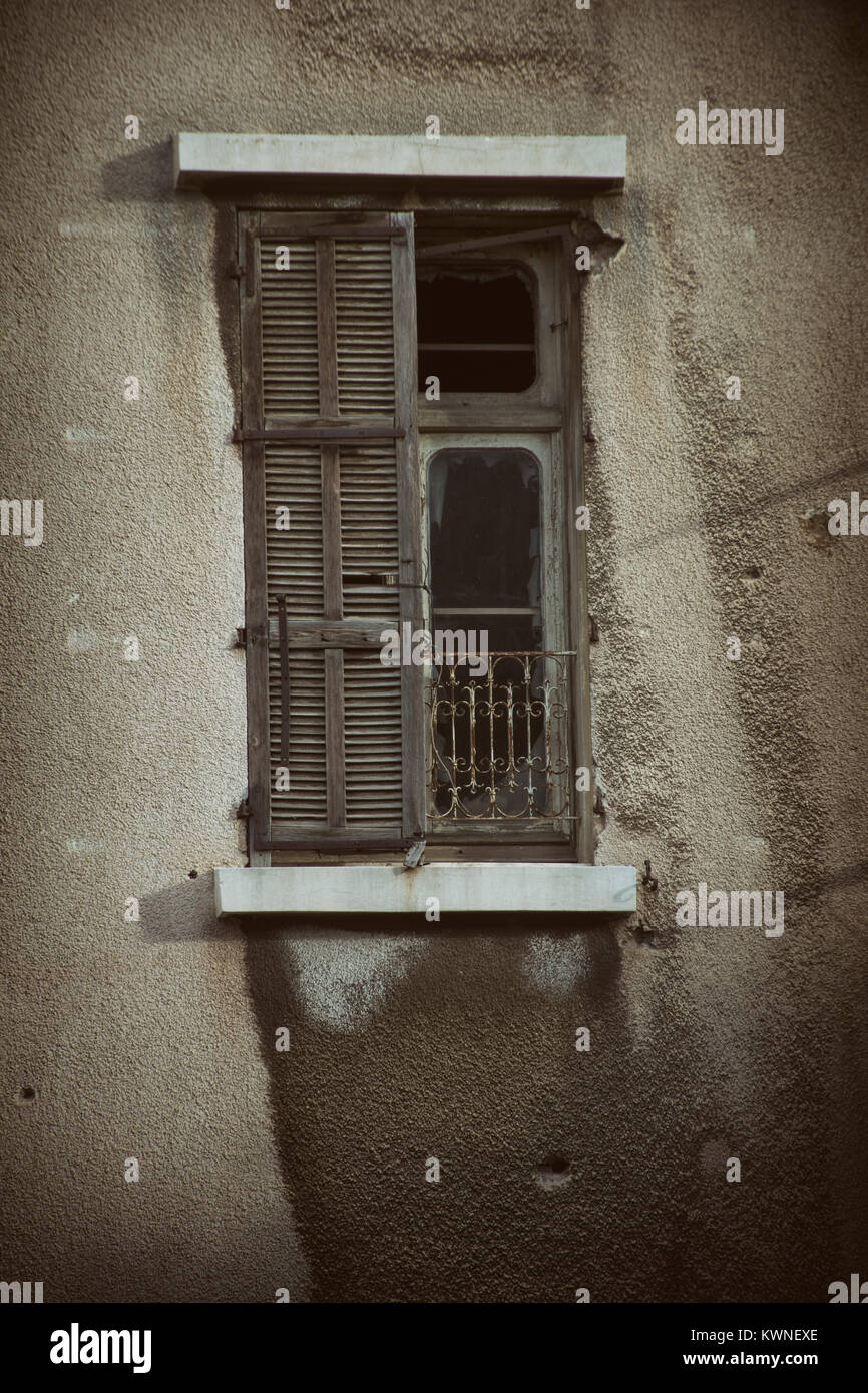 Broken window shutters and lgass of an old building Stock Photo - Alamy