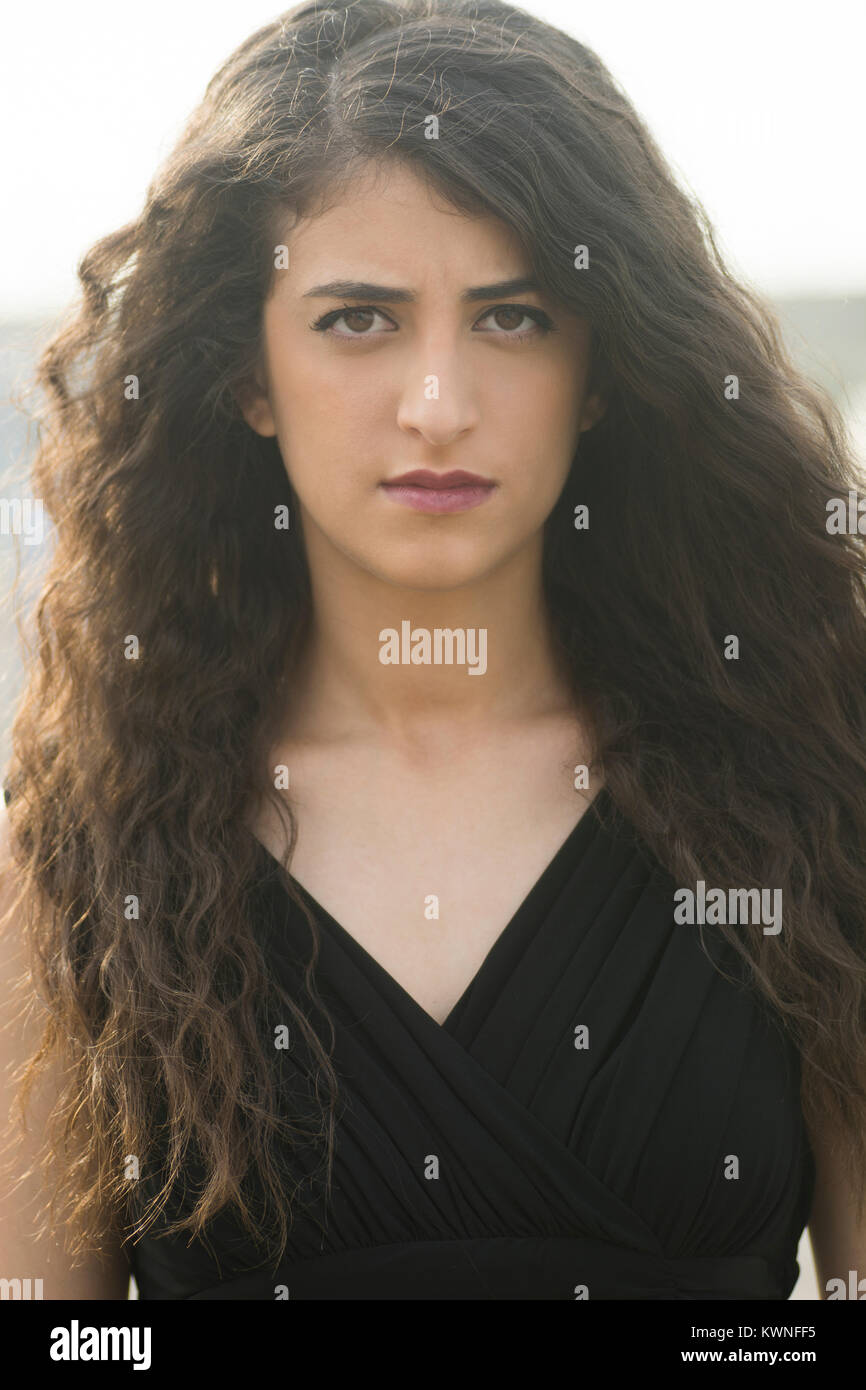 Serious young woman staring outdoors Stock Photo - Alamy