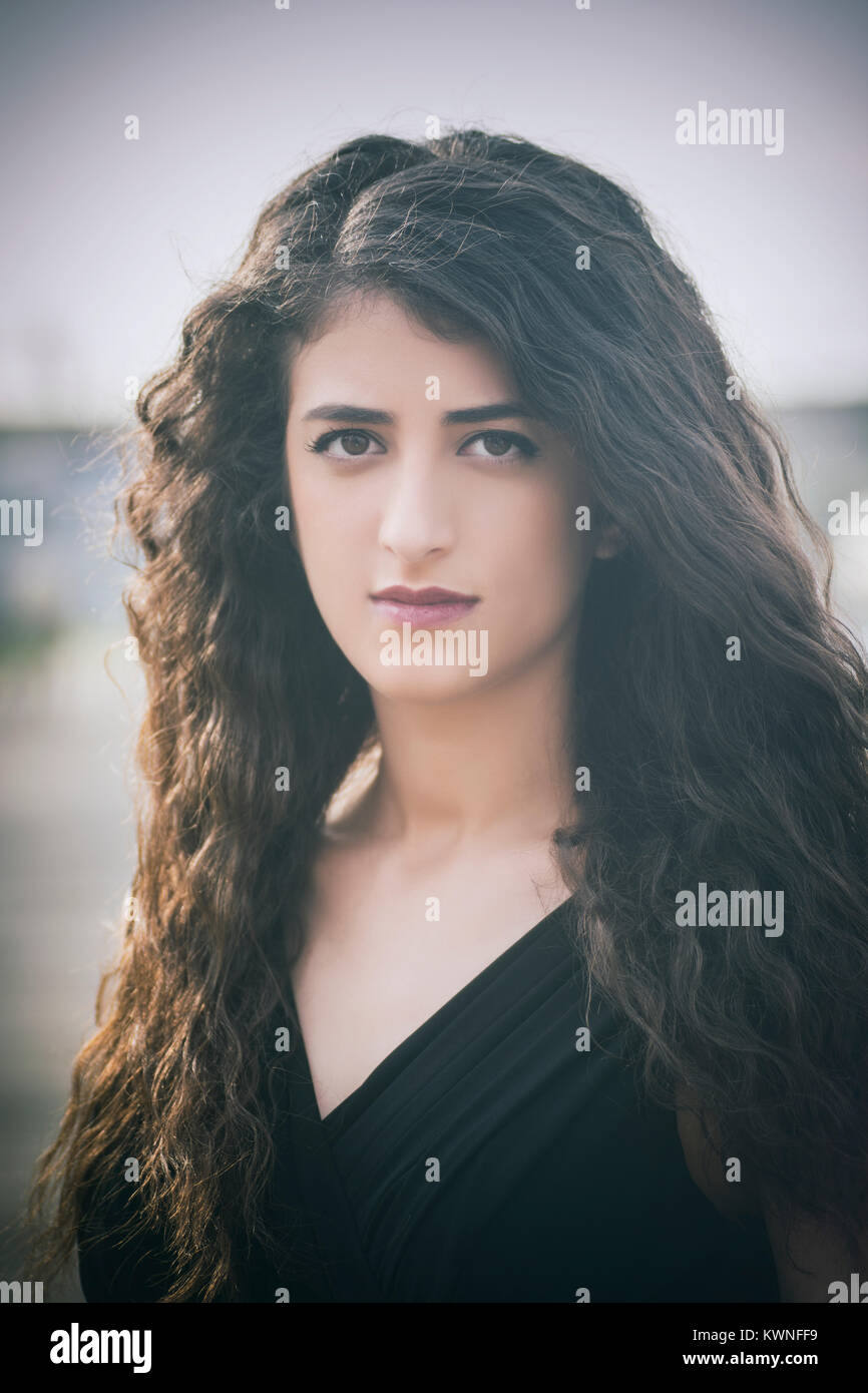 Beautiful young woman staring outdoors Stock Photo - Alamy