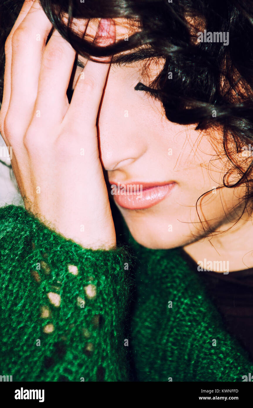 Sad young woman hand on face Stock Photo - Alamy