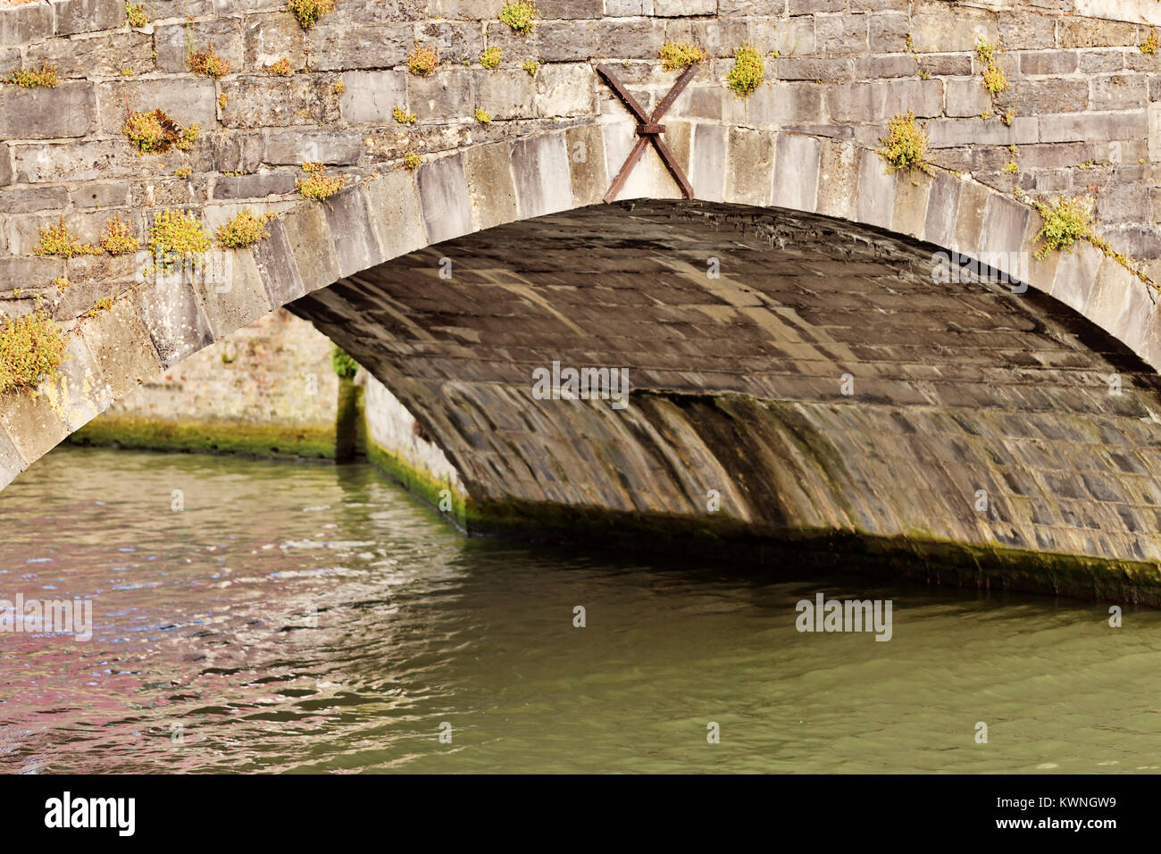 Arch of the ancient bridge from a stone. The bridge over the river with ...