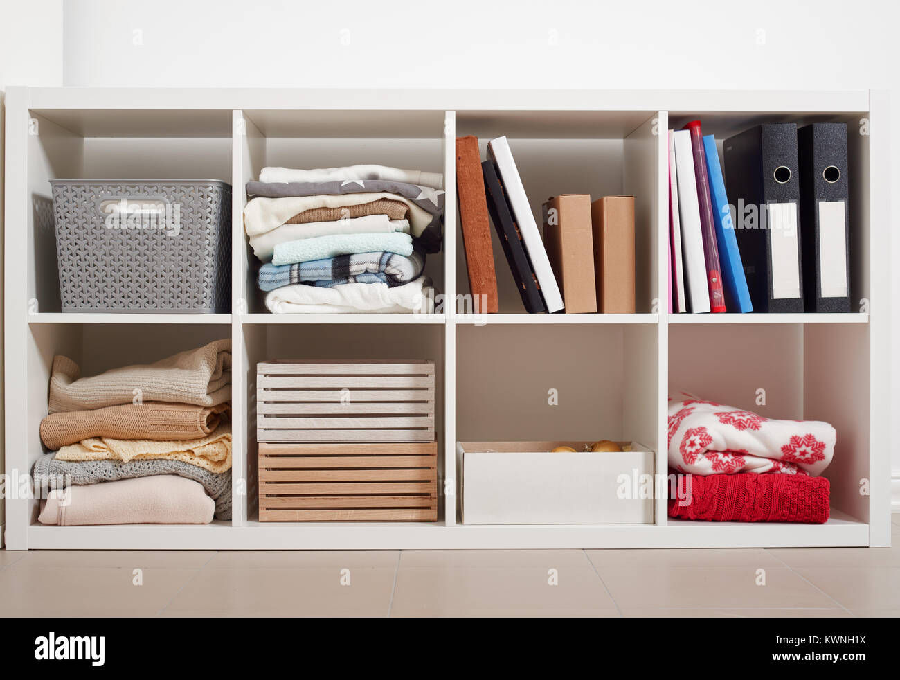 white rack with shelves full of stuff Stock Photo - Alamy