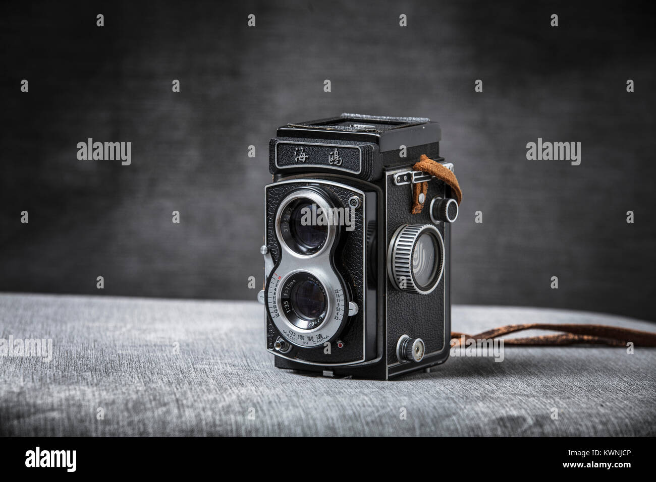 A Seagull 4 TLR Twin Lens Reflex Camera with brown strap on a table ...