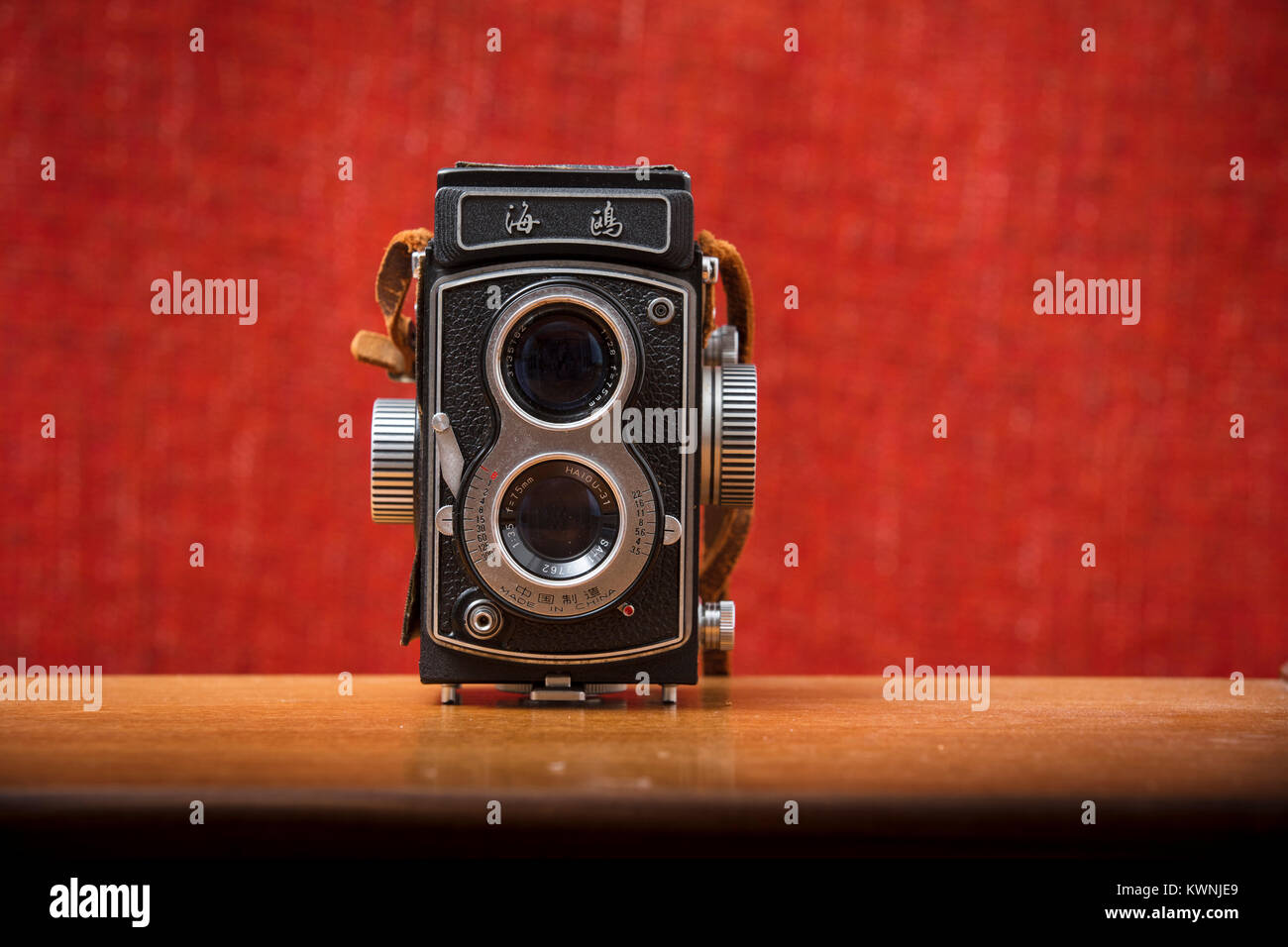 A Seagull 4 TLR Twin Lens Reflex Camera with brown strap on a red ...