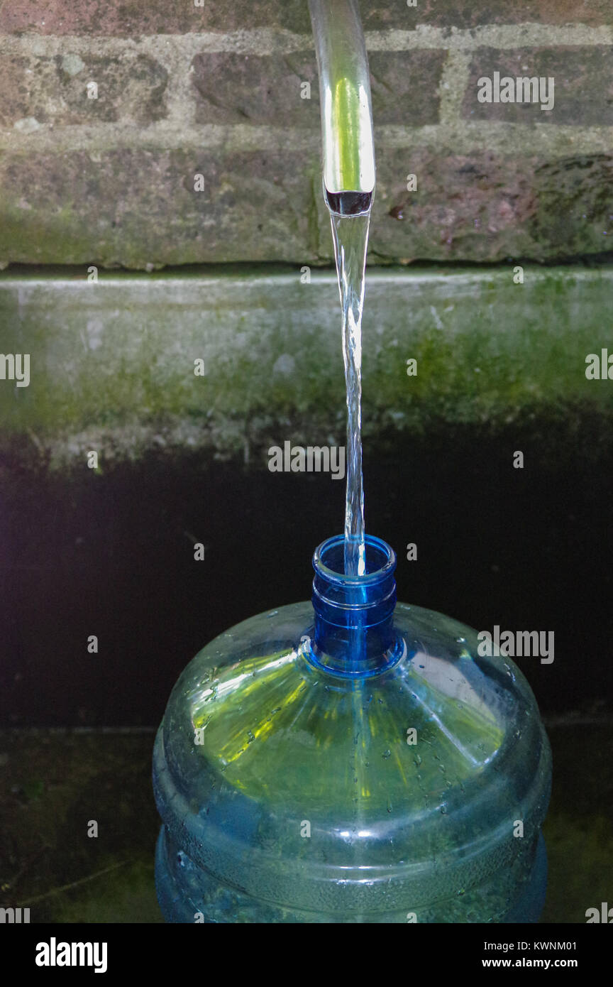 a plastic tank ist filling up from tap with fresh running source water ...