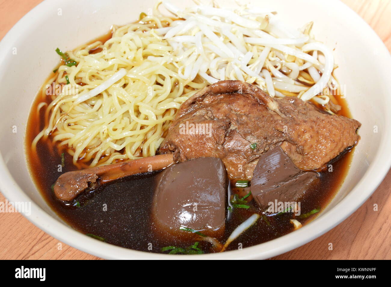 egg noodle with boiled duck in brown soup Stock Photo - Alamy
