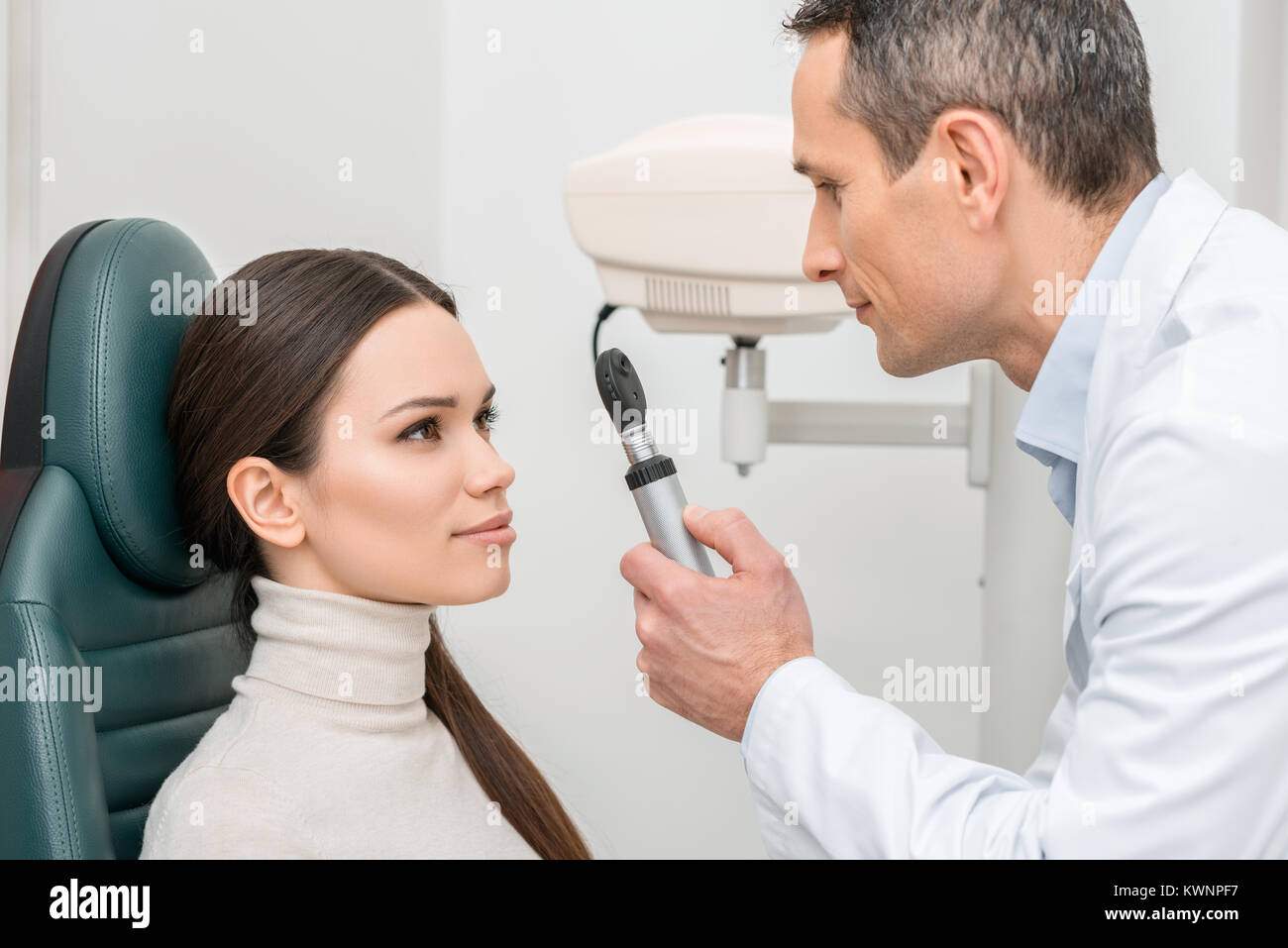 side view of patient getting eye test by oculist in clinic Stock Photo ...