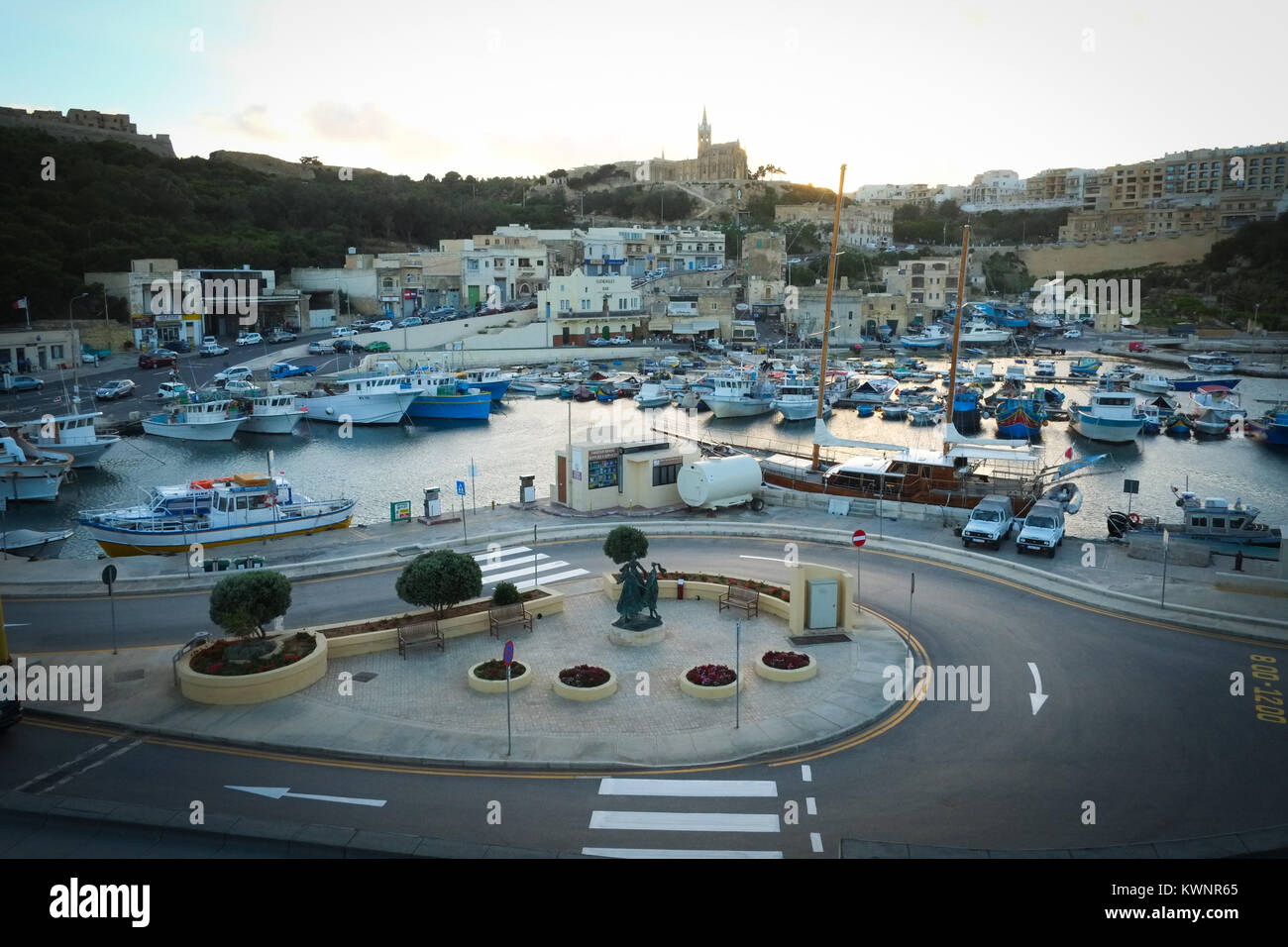 Mgarr harbour, Gozo in the evening light with traditional Maltese ...