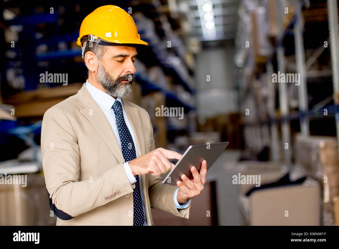 Handsome mature engineer in the warehouse with digital tablet Stock ...