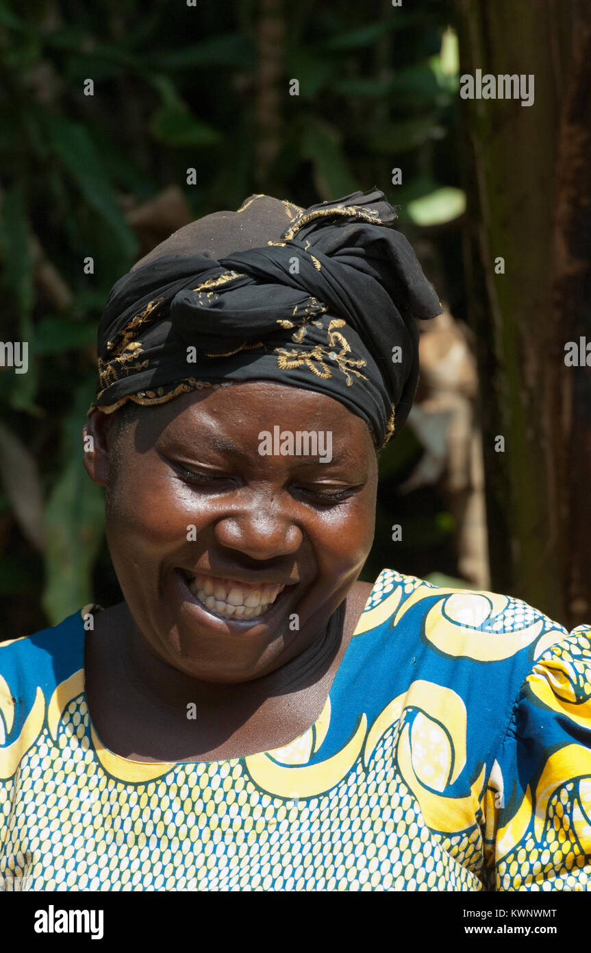 Happy smiling Rwandan lady dressed in bright clothing. Rwanda Stock ...