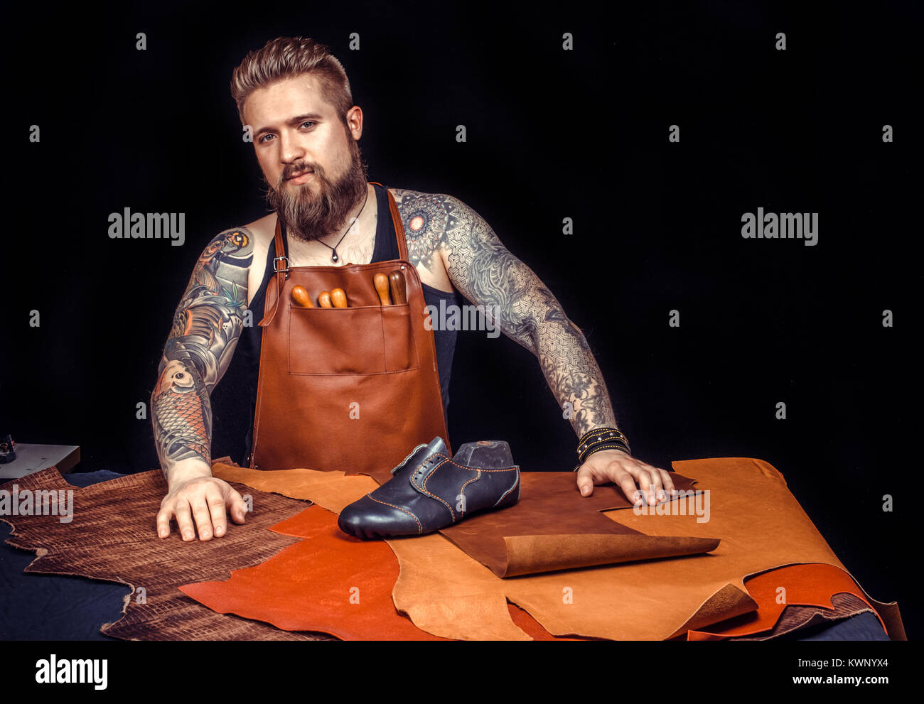 Leather man creating leatherwork in the work area Stock Photo - Alamy