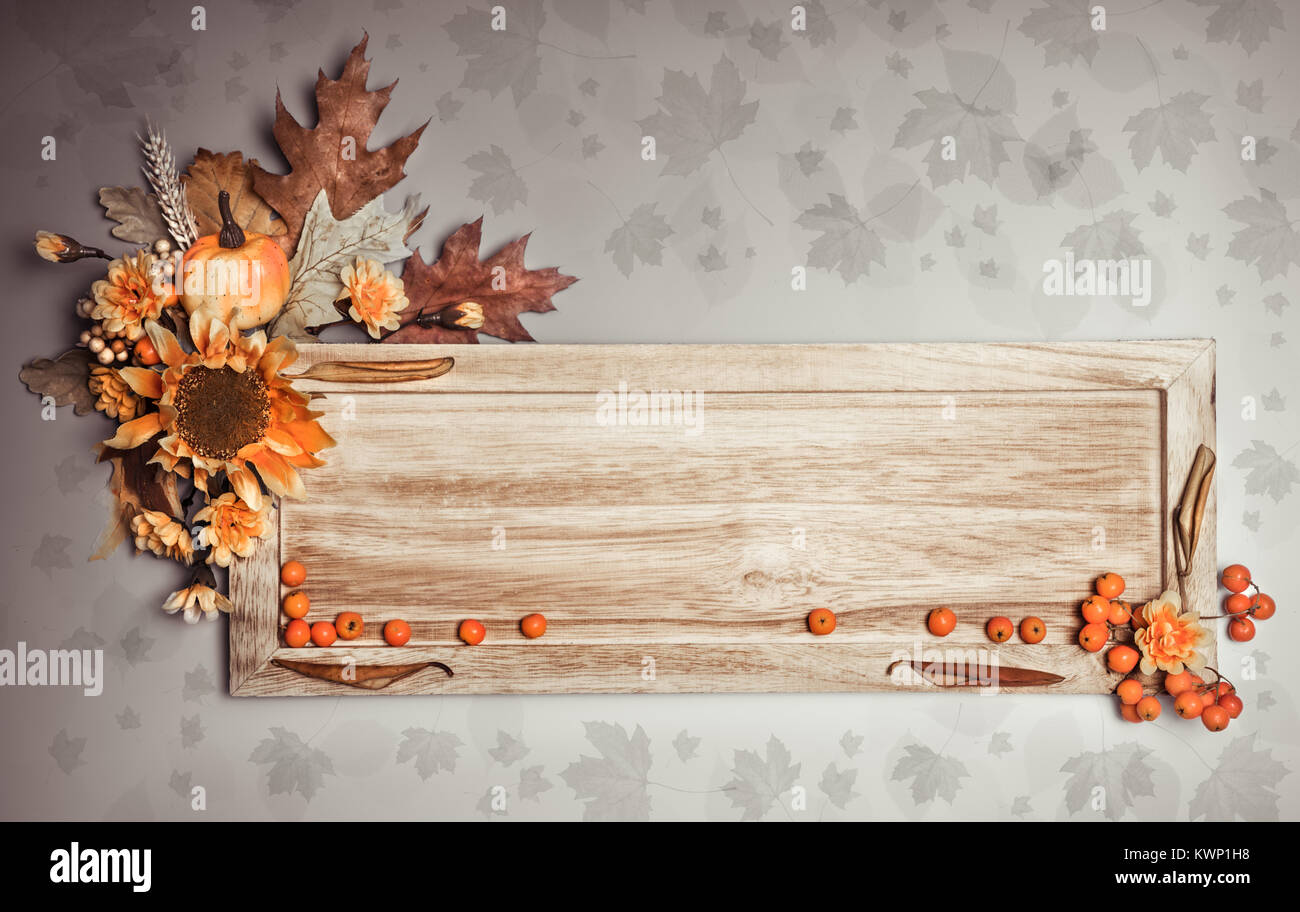 Wooden board with Autumn decorations on natural background, toned image ...