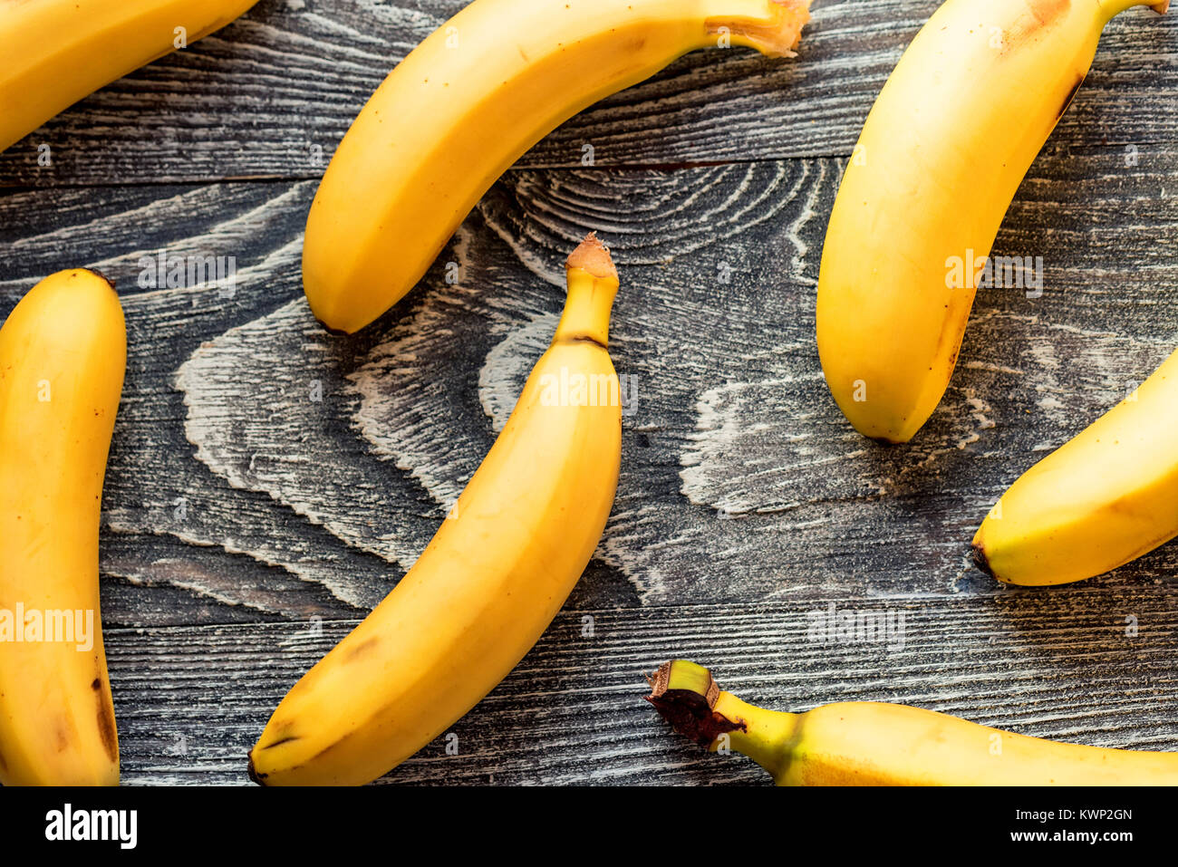 Bunch of bananas on wooden background Stock Photo - Alamy