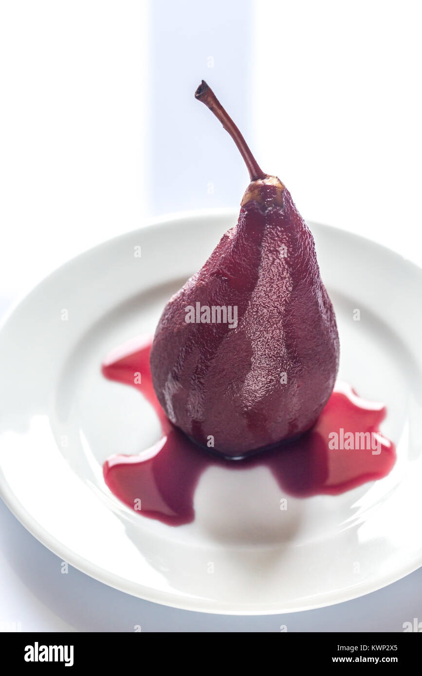 Merlot-poached pear on the plate Stock Photo - Alamy
