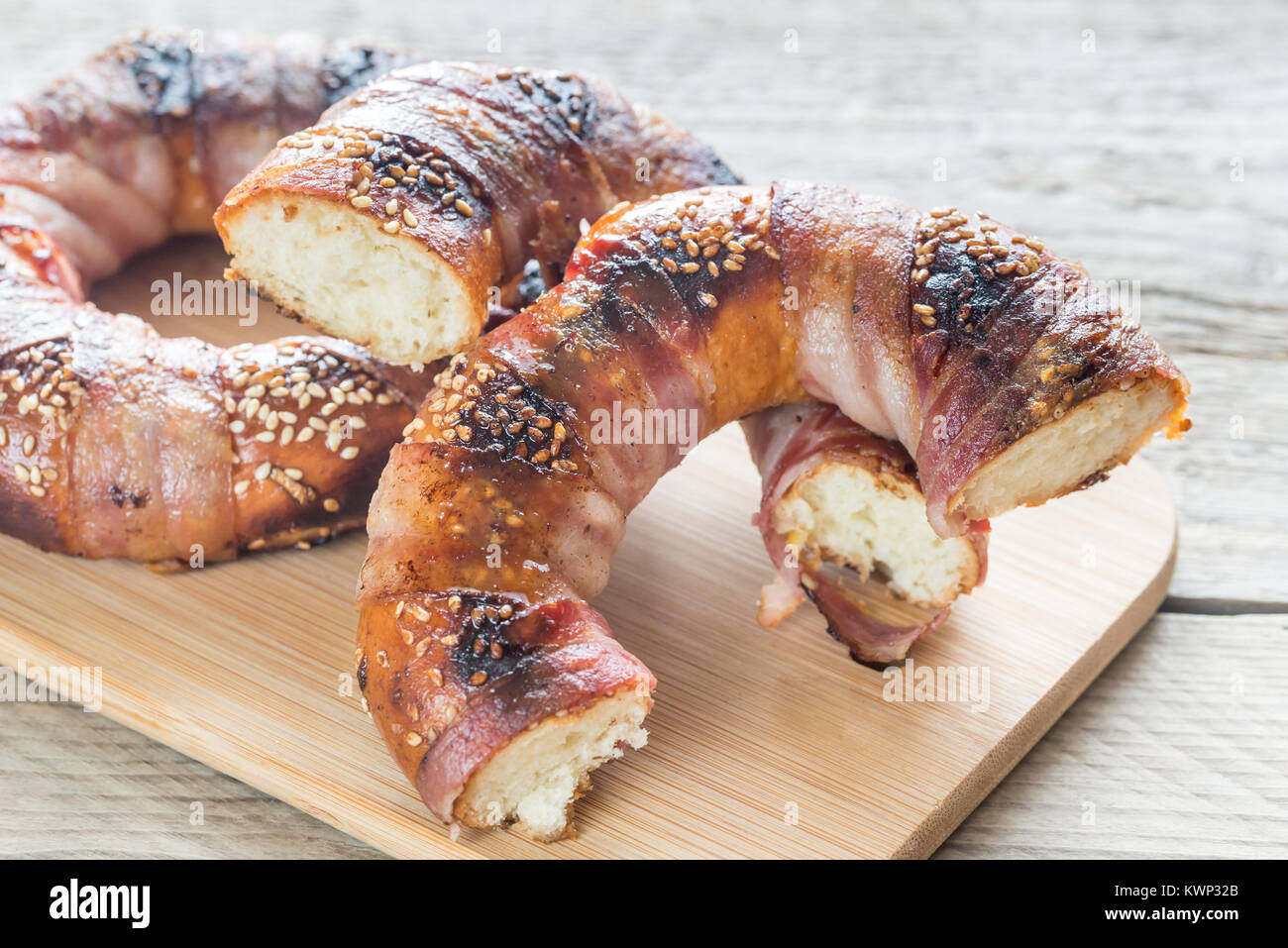 Bagels with sesame wrapped in bacon rashers Stock Photo - Alamy
