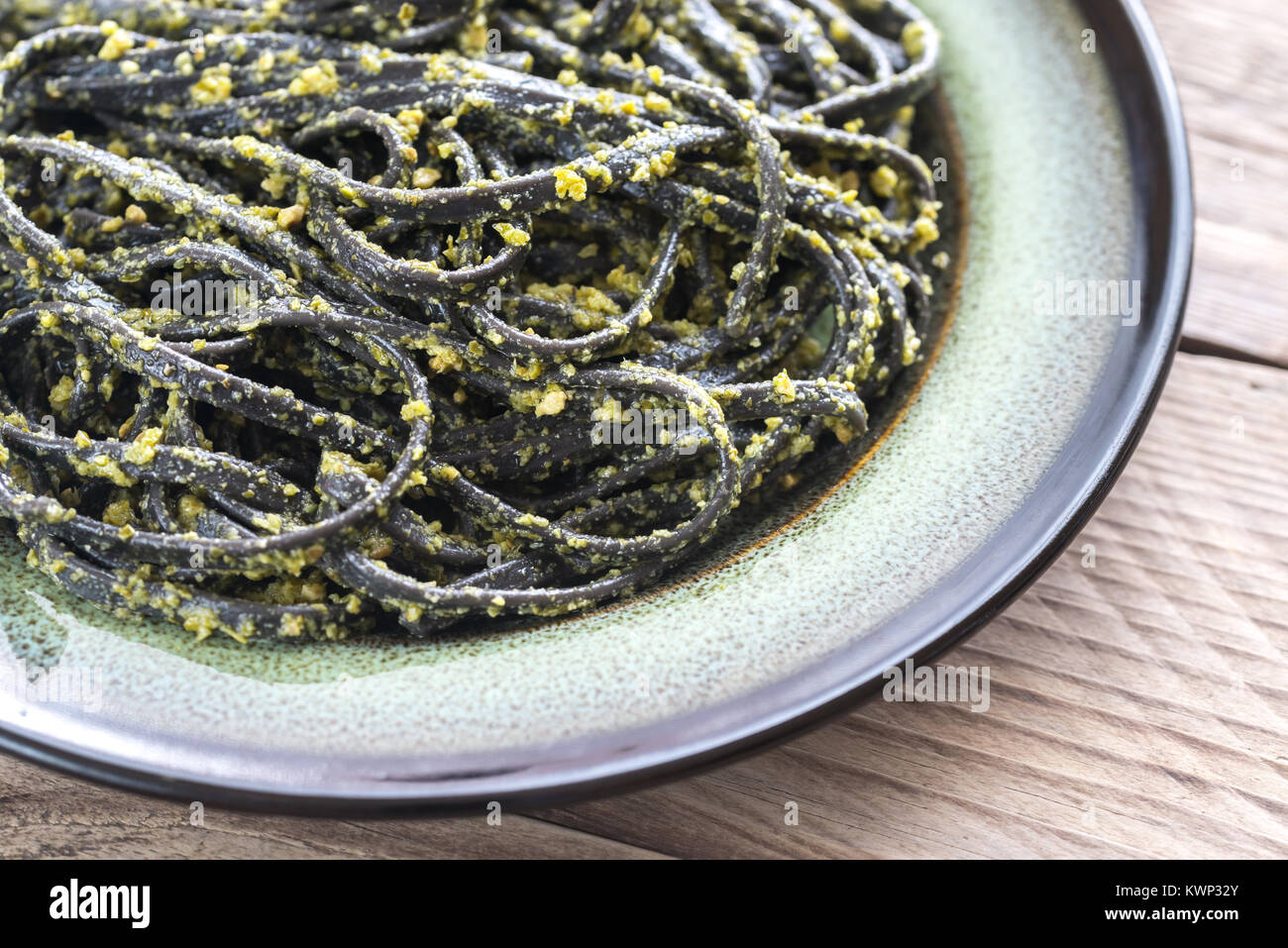 Black pasta with pesto sauce Stock Photo - Alamy