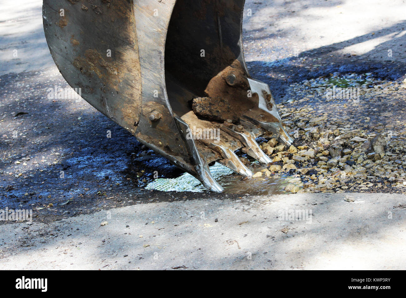 the tractor rests against a defect on the asphalt Stock Photo - Alamy
