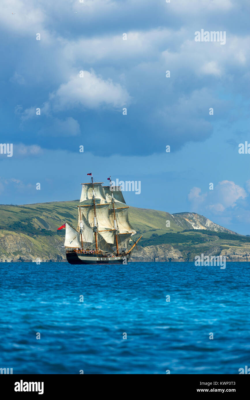 Tall ship the Earl of Pembroke sailing off the Jurassic Coast of Dorset ...