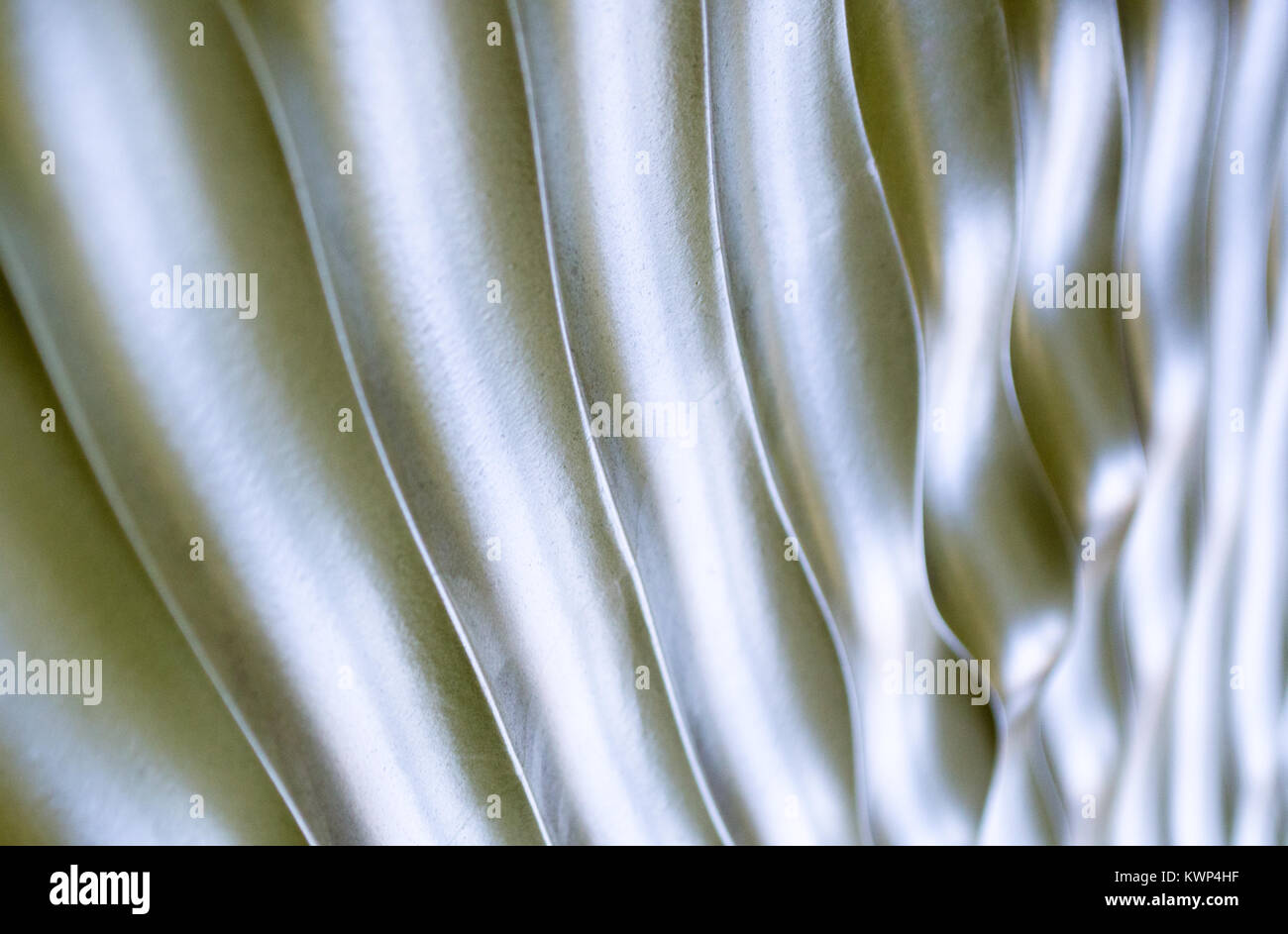 background texture close up of silver undulating metal at an angle with ...