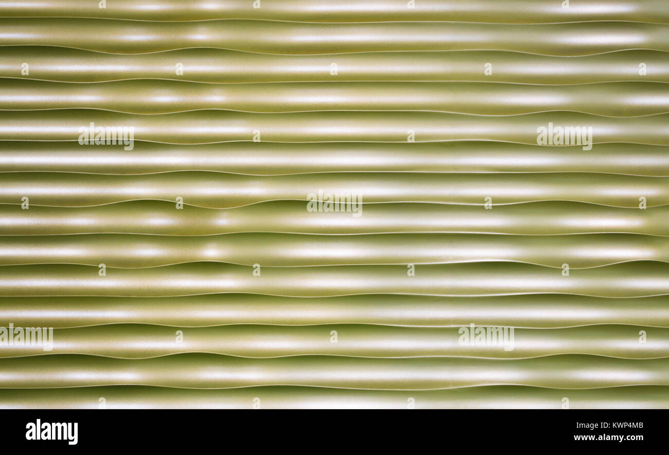 Background Texture Full Frame Close Up Of Golden Undulating Metal With Contrast And Shadows