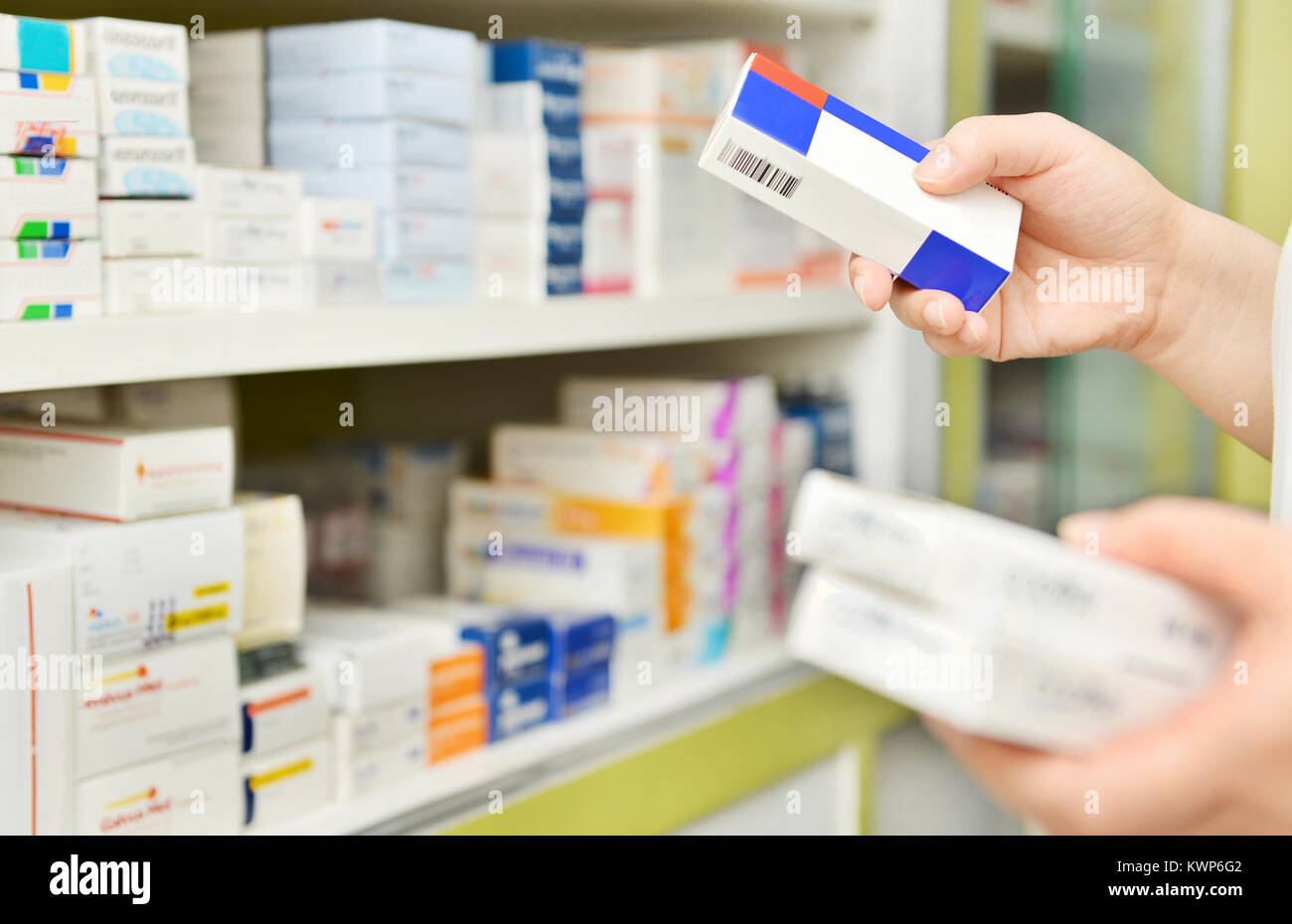 Pharmacist holding medicine box in pharmacy drugstore Stock Photo - Alamy