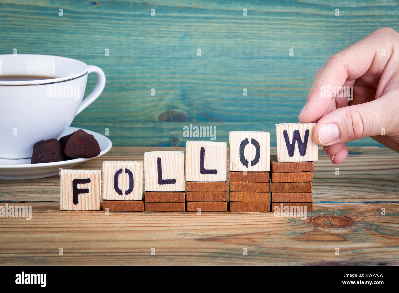 follow. Wooden letters on the office desk, informative and ...