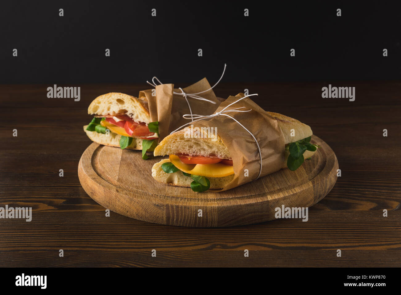 two cooked delicious panini with vegetables on wooden board Stock Photo ...